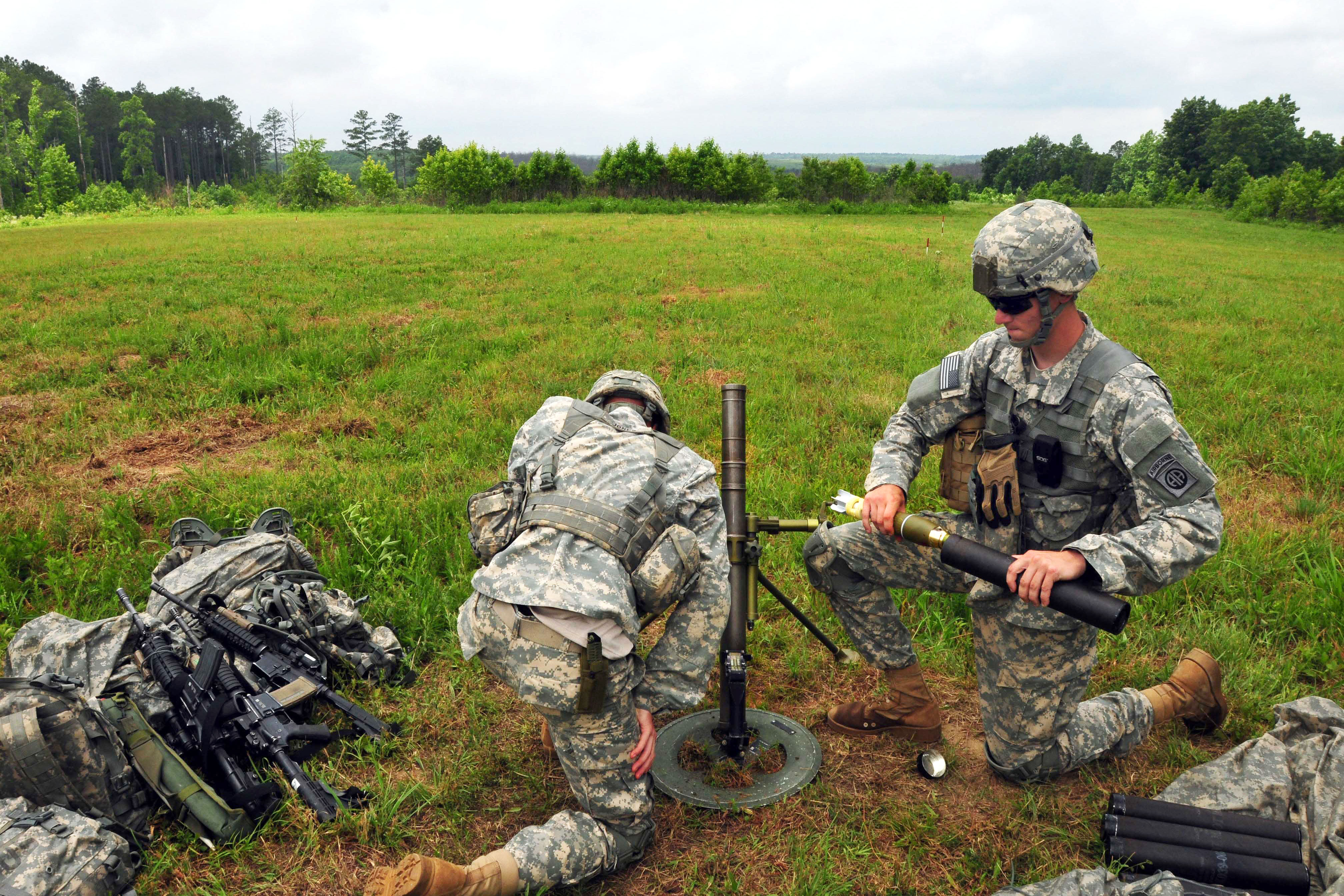 Army Pfc. Trevor G. Martin, right, prepares a 60mm mortar round during ...