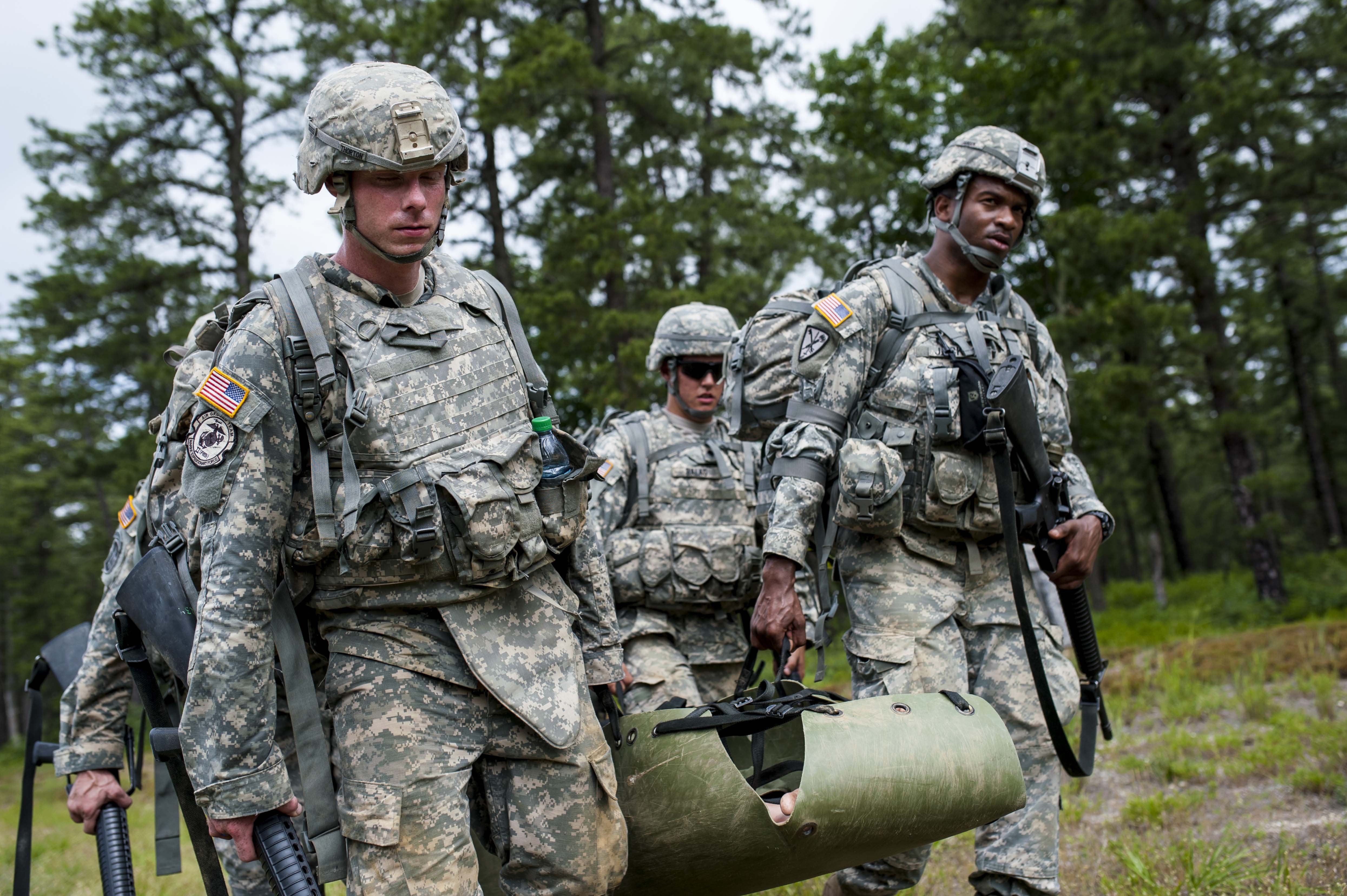 Army Staff Sgt. James Thornton, left, and Sgt. Juan Jackson carry a 165 ...