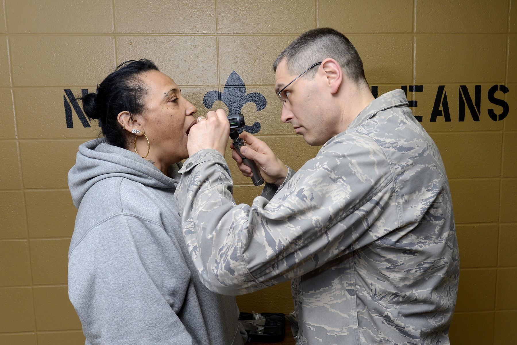Air Force Lt. Col. Eric N. Erickson examines a patient during Cajun ...
