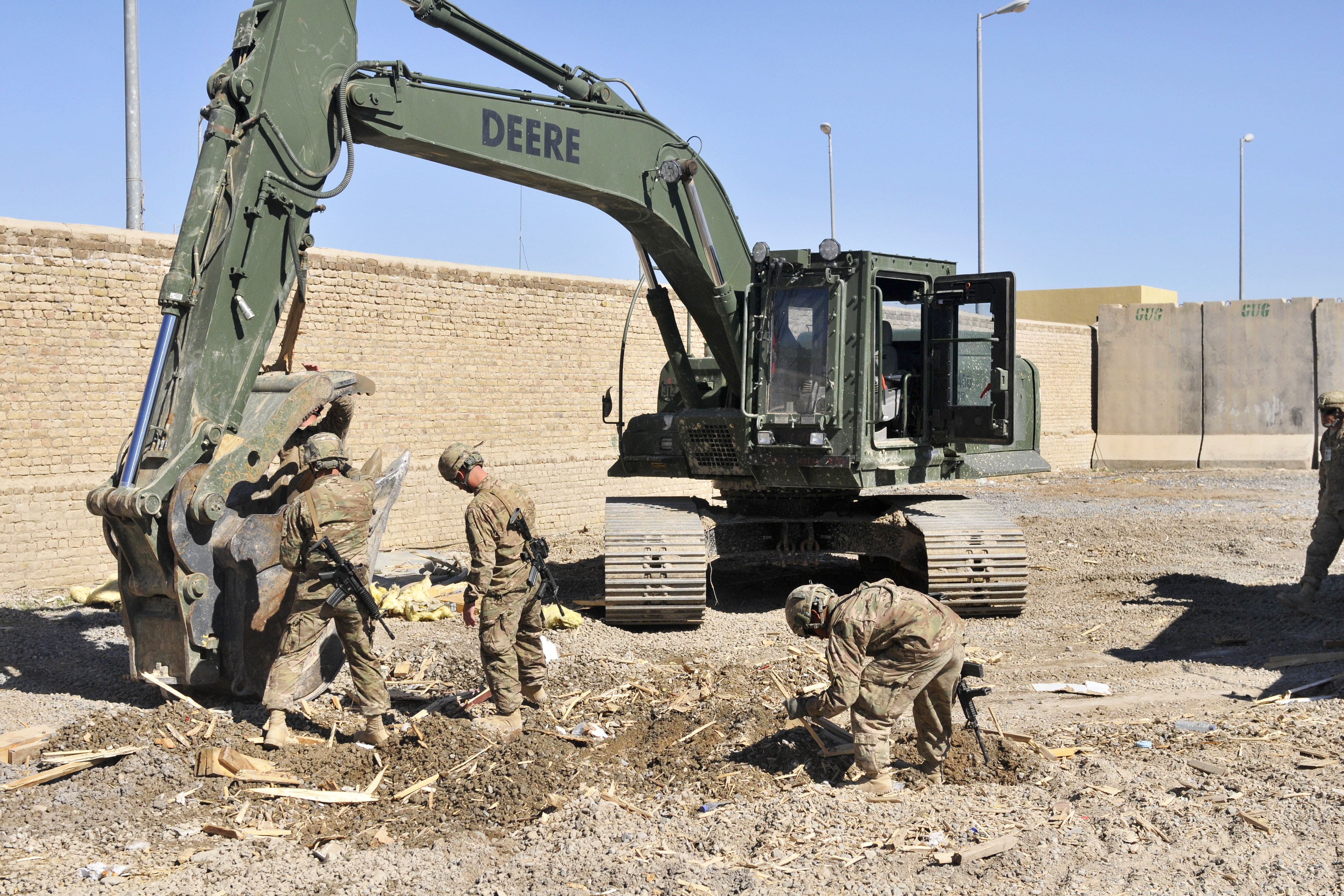 U S Soldiers Clean Up Wood Fragments After Using Heavy Machinery To