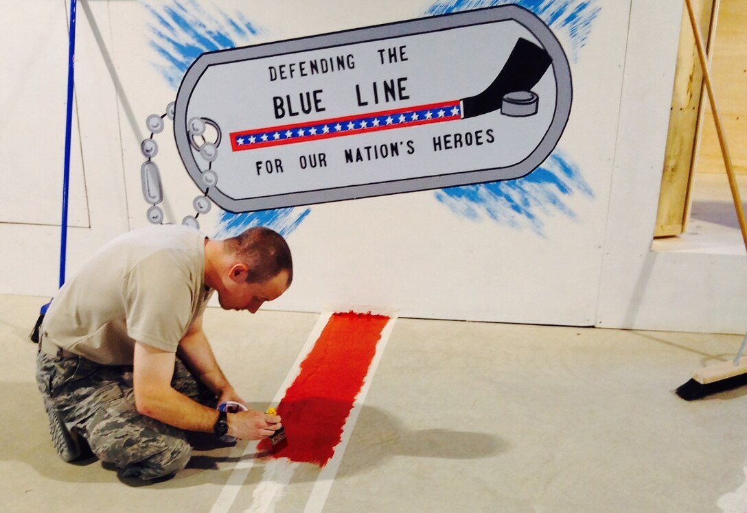 Air Force Airman 1st Class Joshua Hanson, 386th Expeditionary Communication Squadron, paints the ...