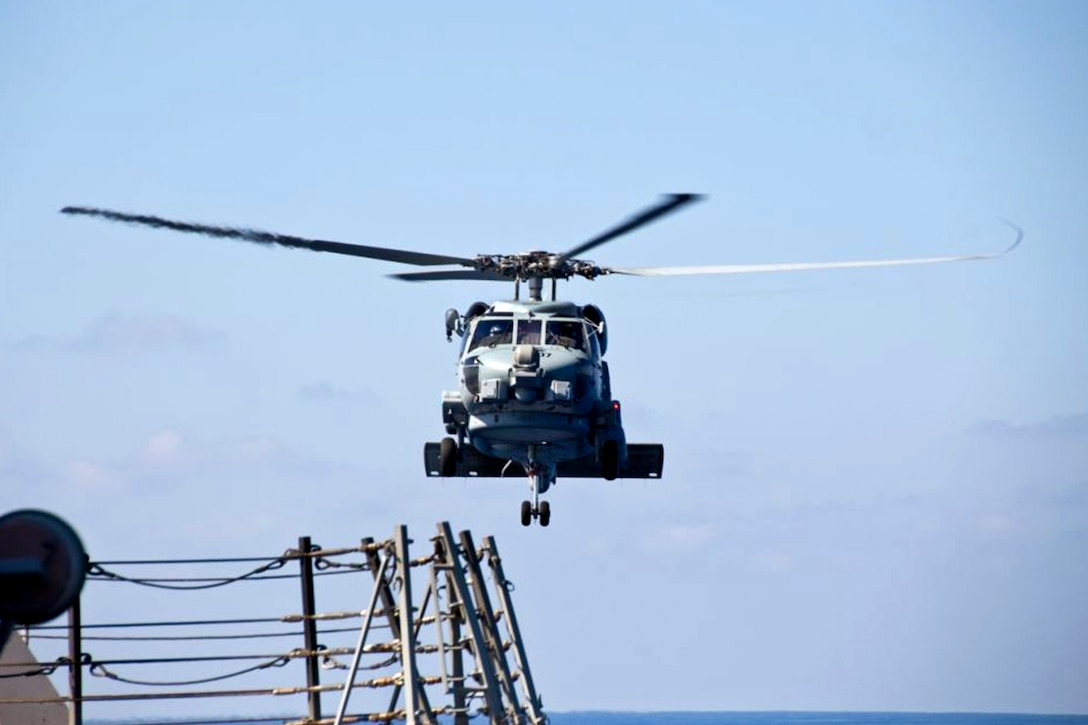 A U.S. Navy SH-60R Seahawk helicopter from the destroyer USS Pinckney ...