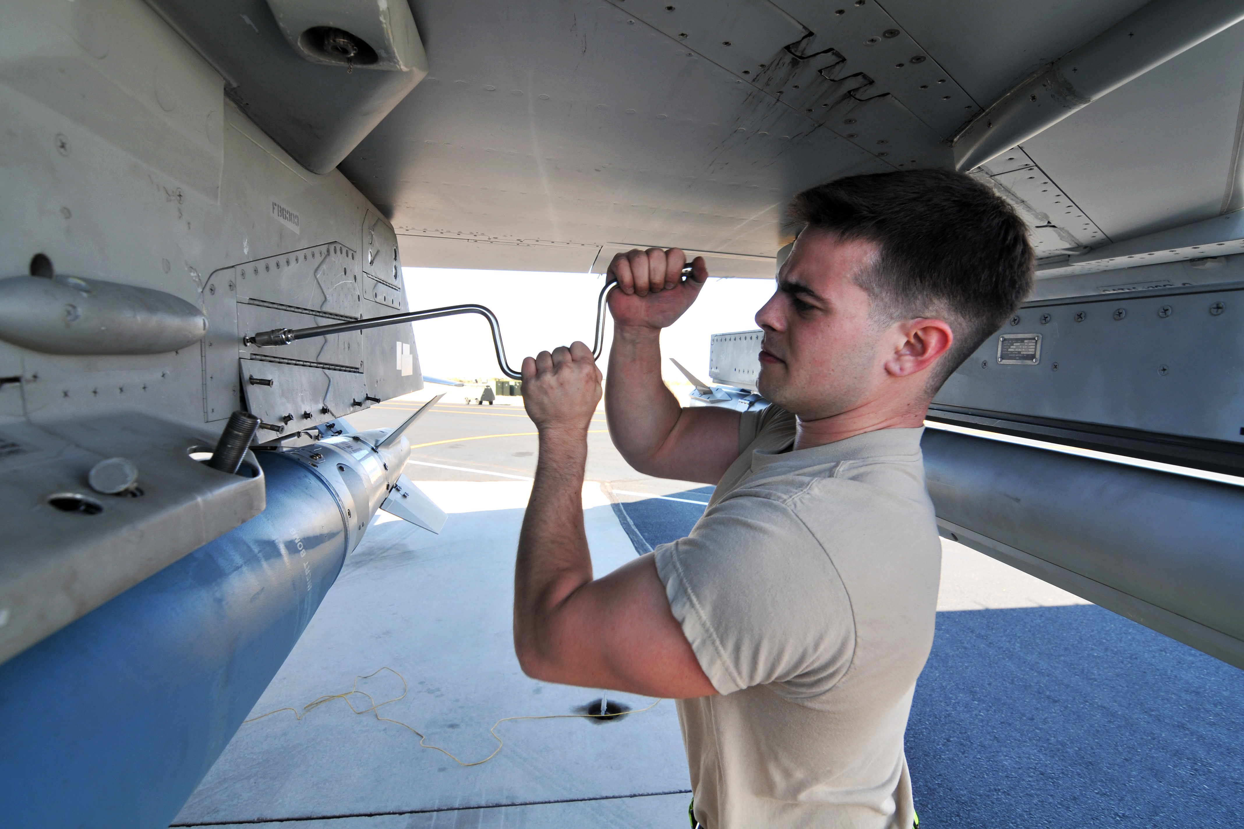 Air Force Senior Airman Vince Avallone tightens side panel bolts on a ...