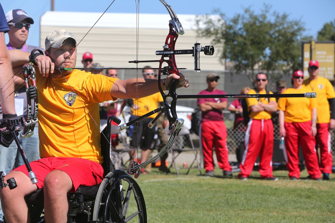 Marine Corps veteran Jake Stadler Jr. draws back to release an arrow ...