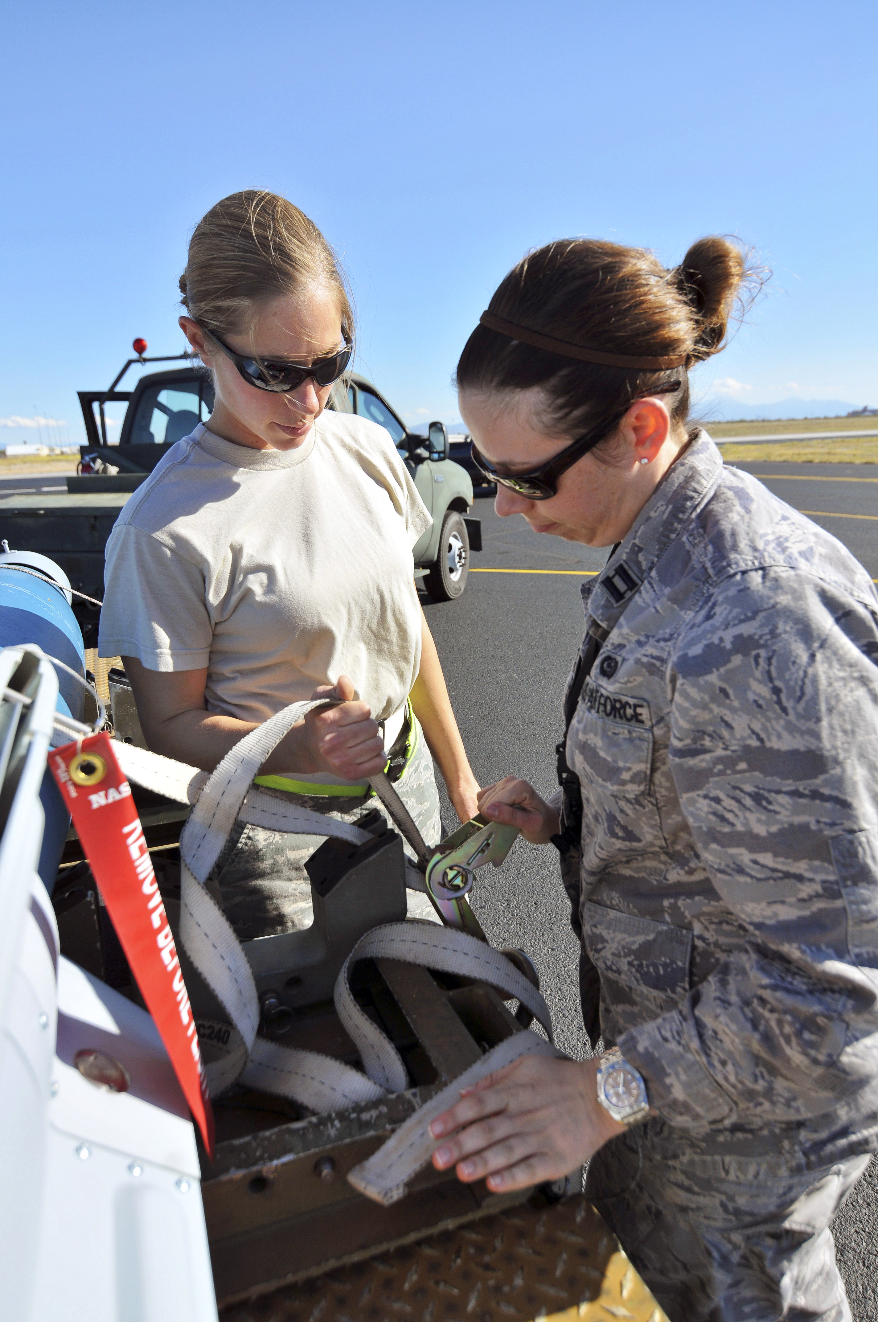 Air Force Staff Sgt. Jennifer Lauer, left, helps Air Force Capt ...