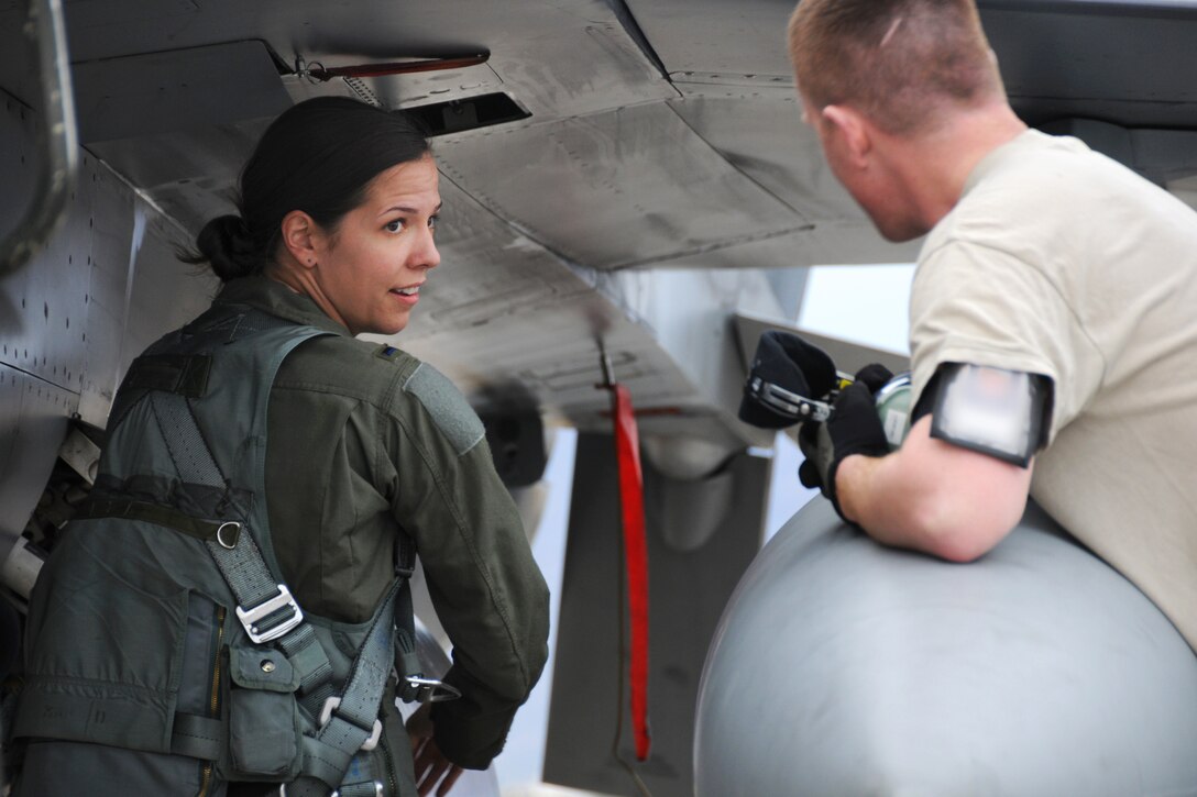 Air Force 1st Lt. Janelle Baron, left, inspects an F-16C Fighting ...