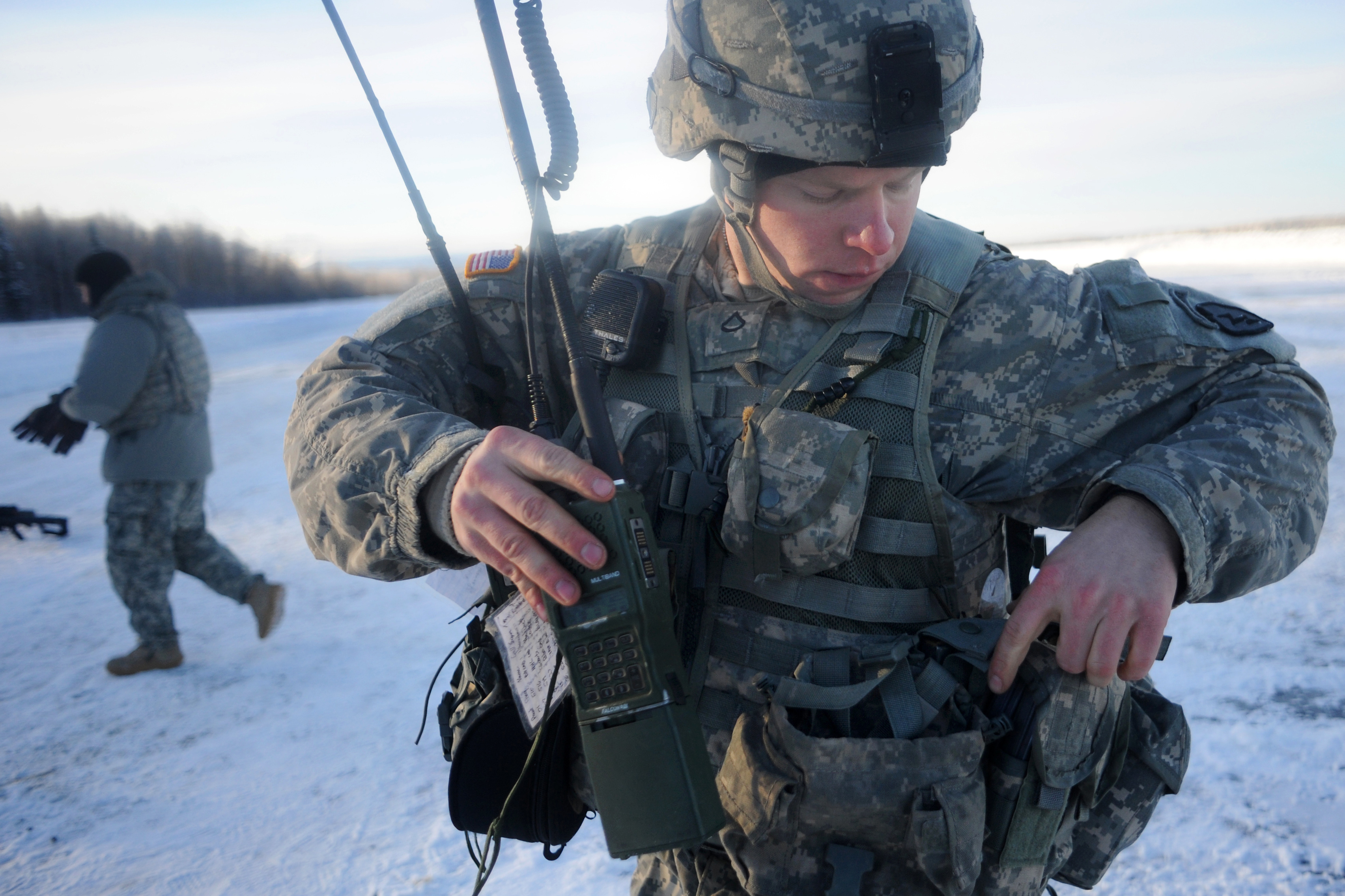Army Pfc. Ryan Pepp prepares a radio as fellow soldiers train with the ...