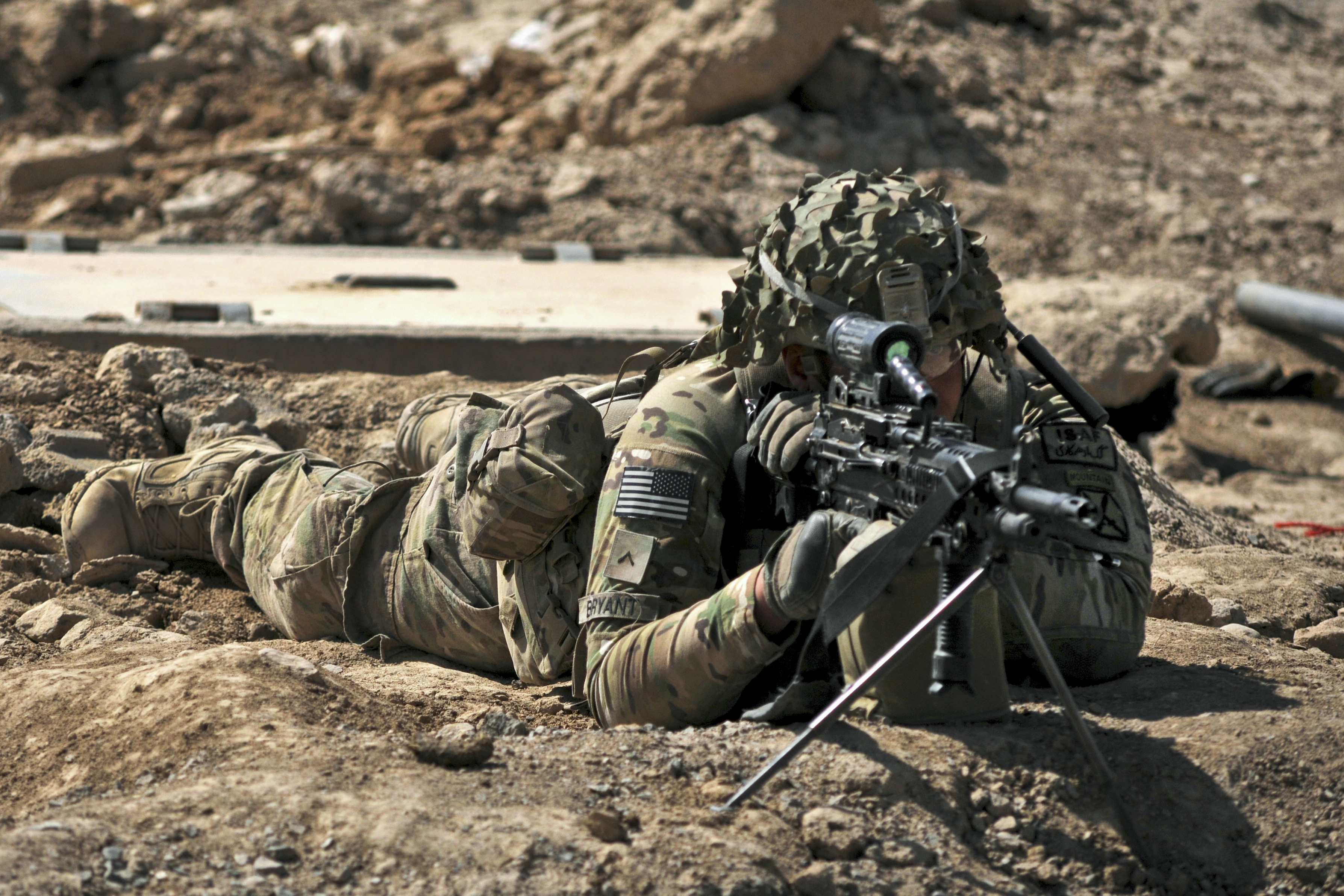 U.S. Army Pvt. David Bryant mans his position behind his M249 automatic ...