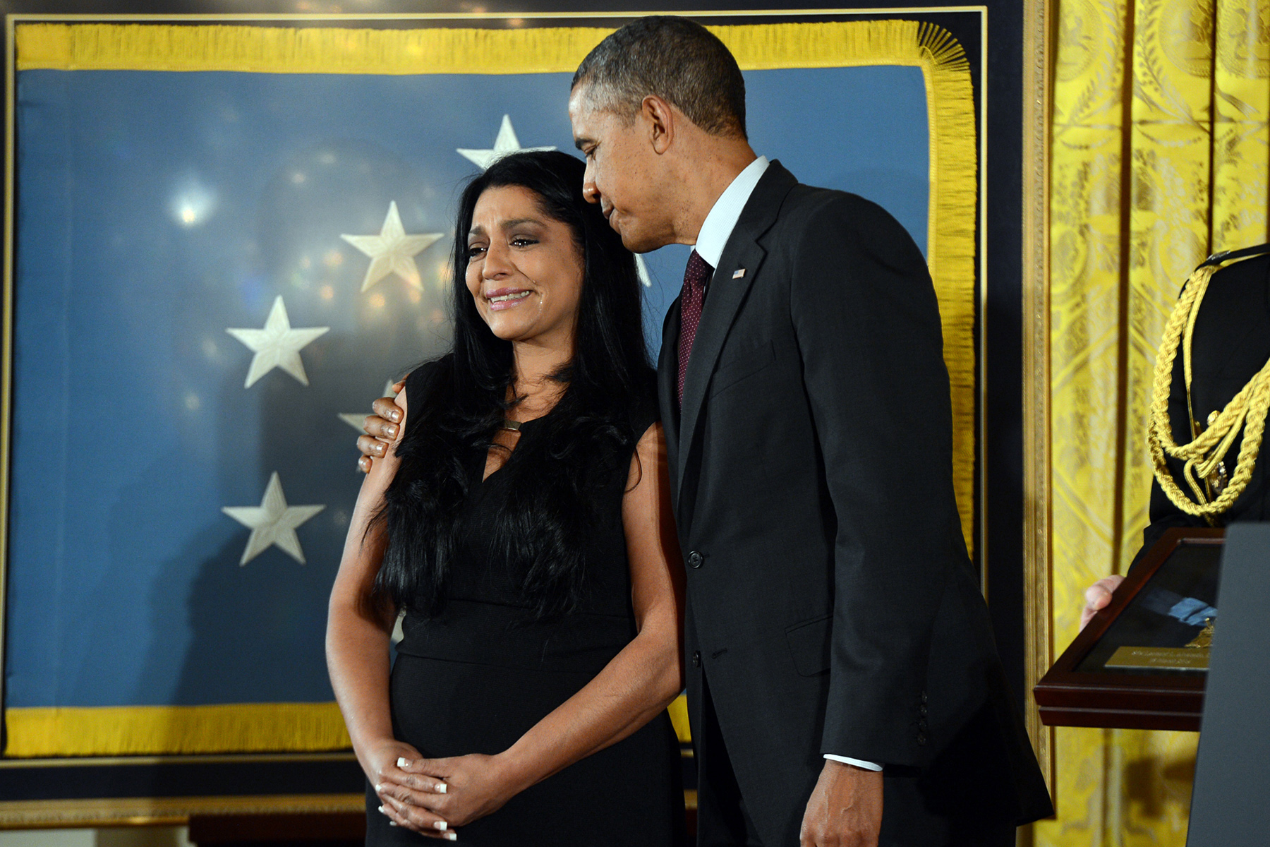 President Barack Obama comforts Lenora Alvarado, who accepted the Medal ... President Barack Obama comforts Lenora Alvarado, who accepted the Medal ...