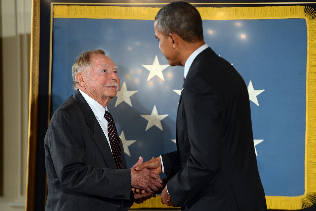 Robert Nietzel accepts the Medal of Honor on behalf of his late first ...