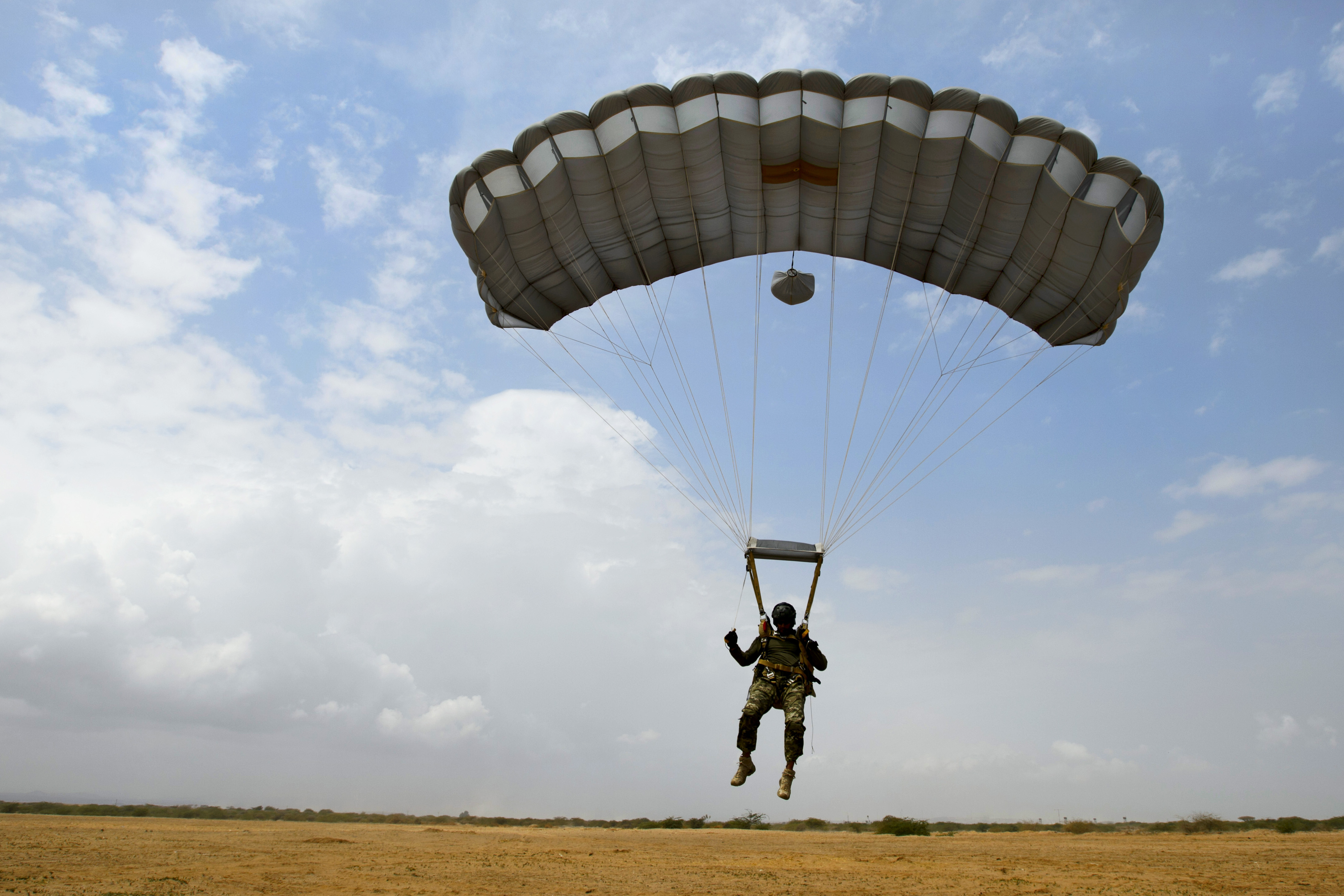 A U.S. Air Force pararescueman lands during free fall jump training ...