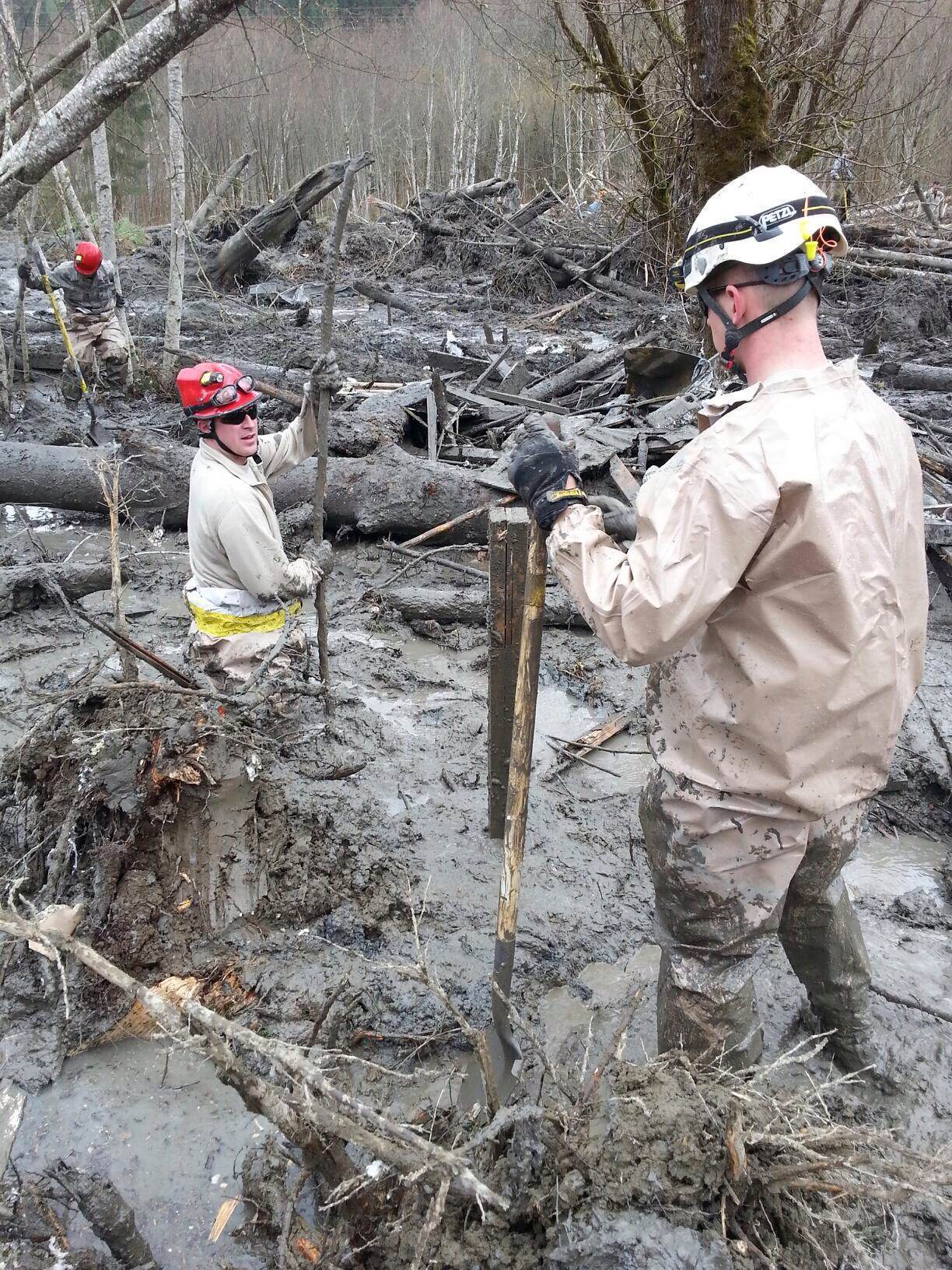 Air Force Master Sgt. Eva Mayberry removes debris by hand looking for ...
