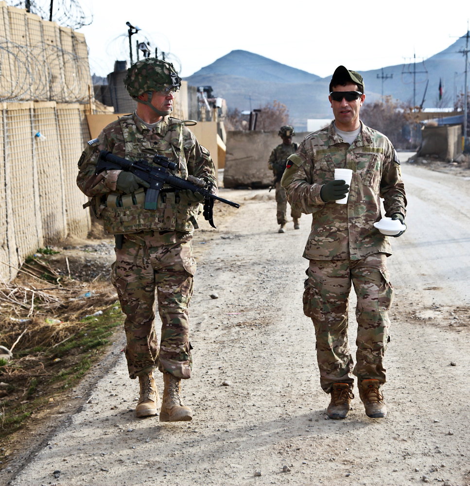 U.S. Army Lt. Col. Robert Owen, left, walks to the Operation ...