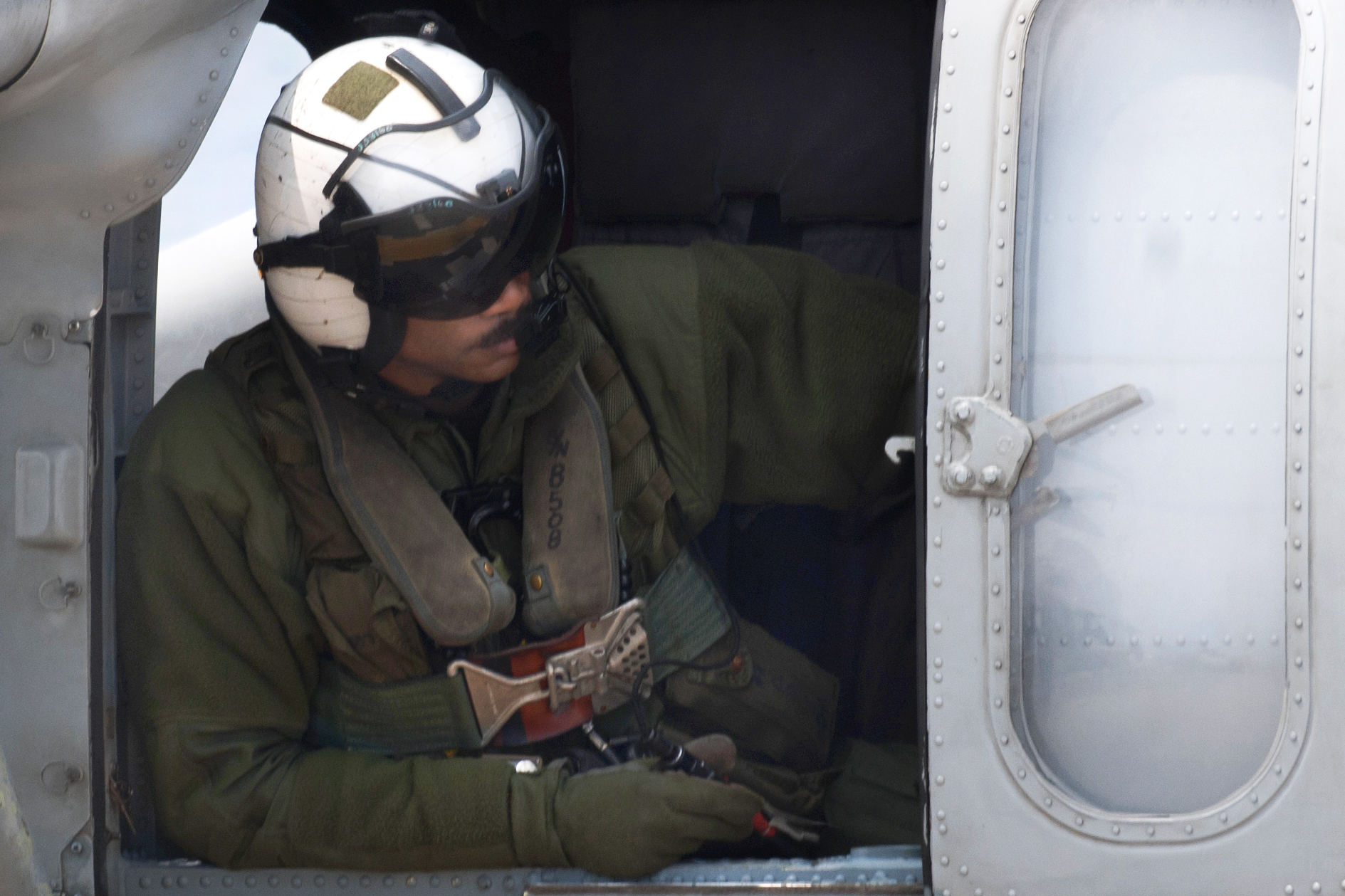 U.S. Navy Petty Officer 1st Class Reginald Harvey acts as a safety ...