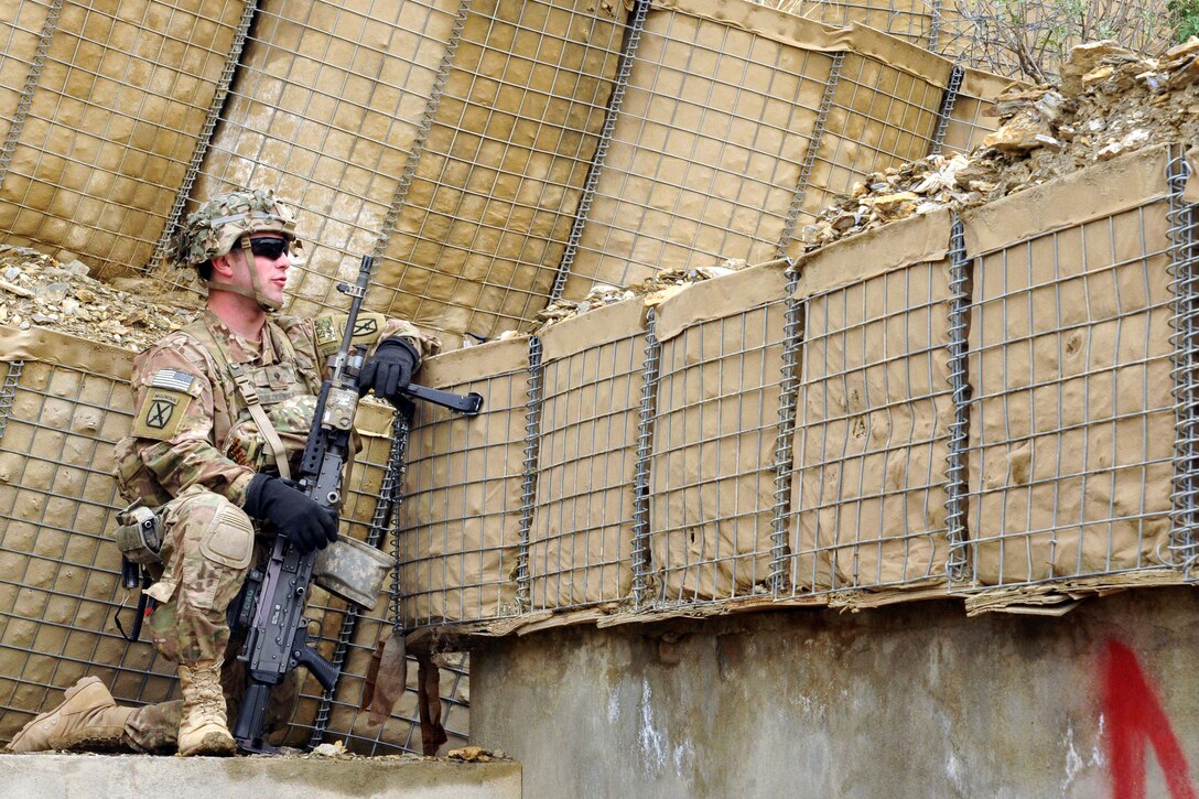 A U.S. soldier takes a knee at his post during a mission to provide ...