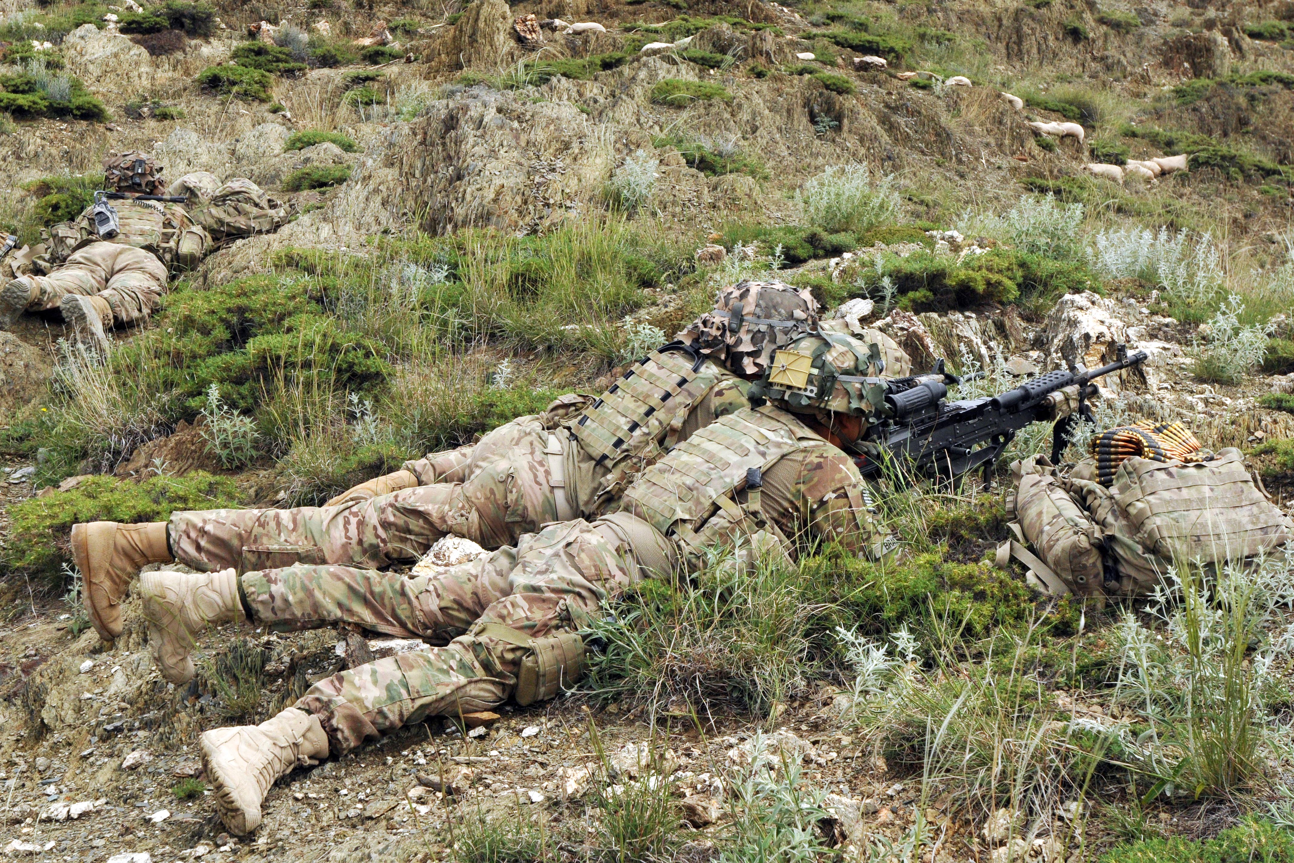 U.S. soldiers man an over watch fighting position during their mission ...