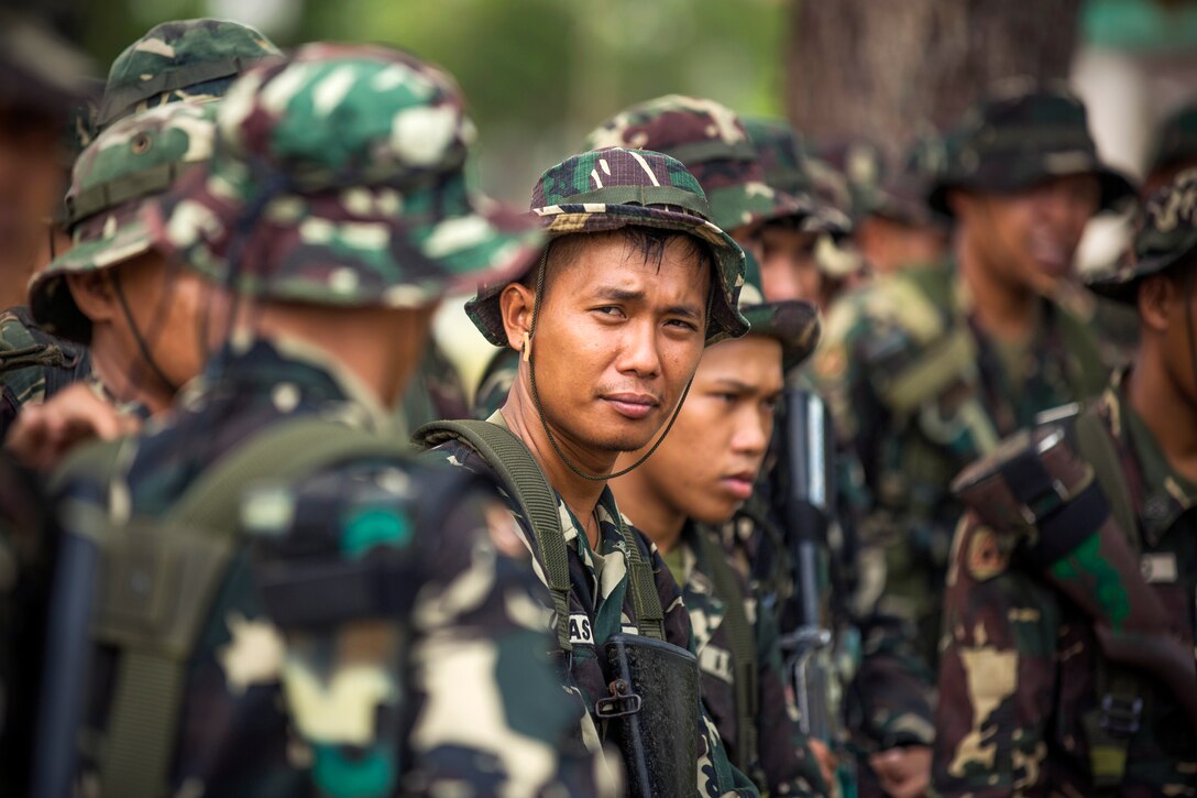 Philippine Army Pfc. Alex Jatass, center, waits to start helicopter ...
