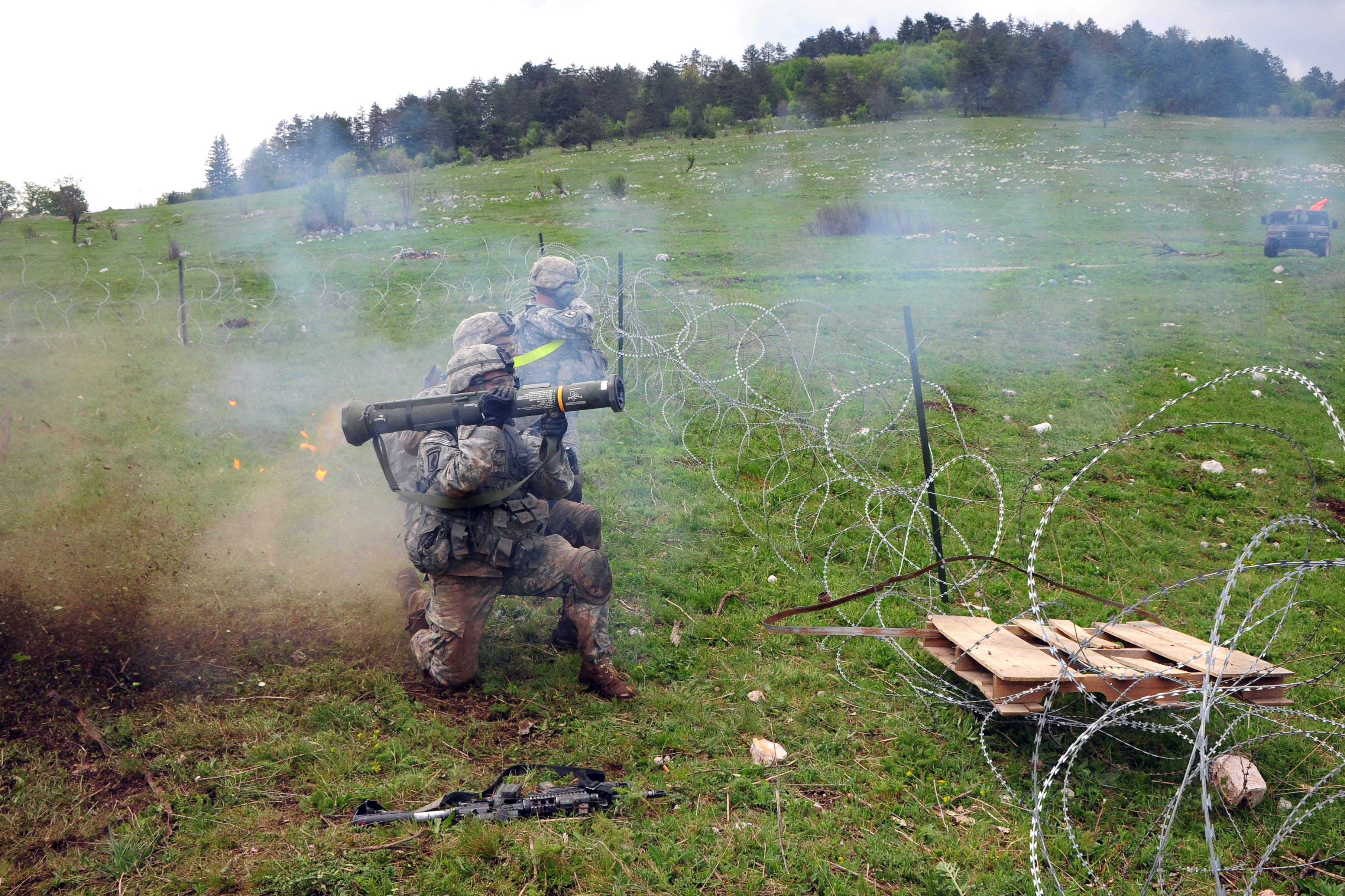 A U.S. paratrooper engages a target with an AT4 anti-tank grenade ...