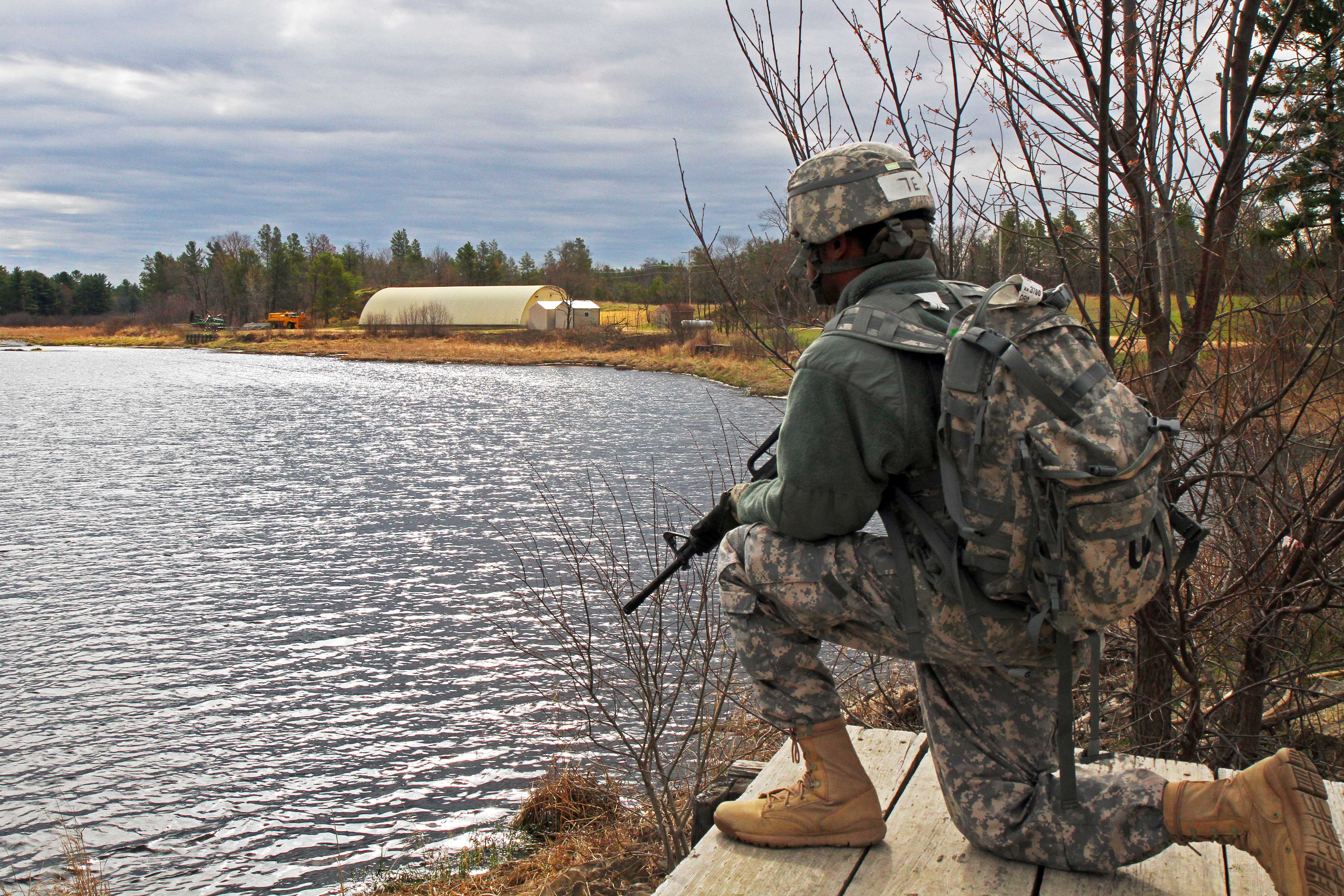Army Spc. Chase Johnson provides cover as his team measures a bridge ...