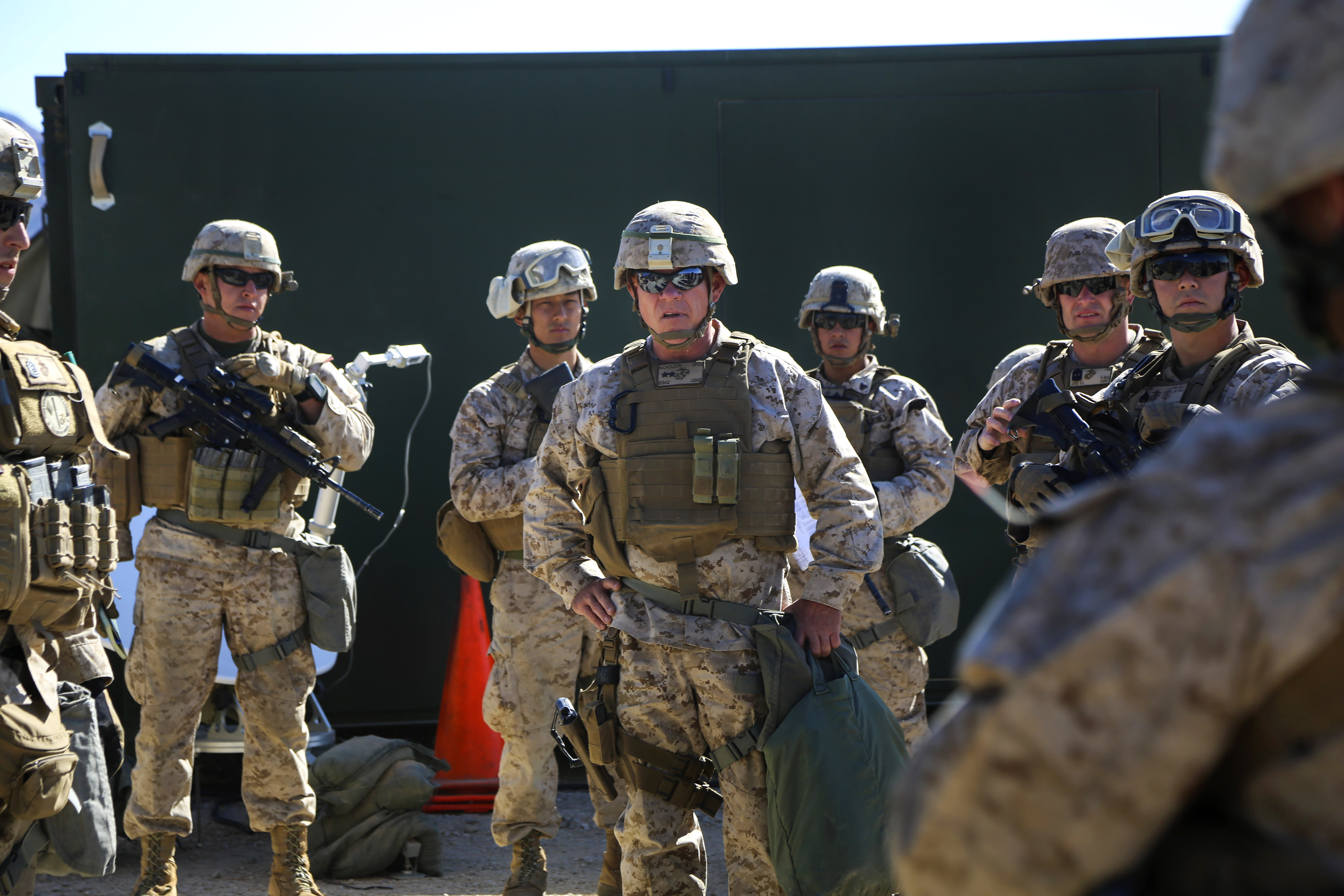 Marine Corps Maj. Gen. Lawrence D. Nicholson, center, listens to a ...