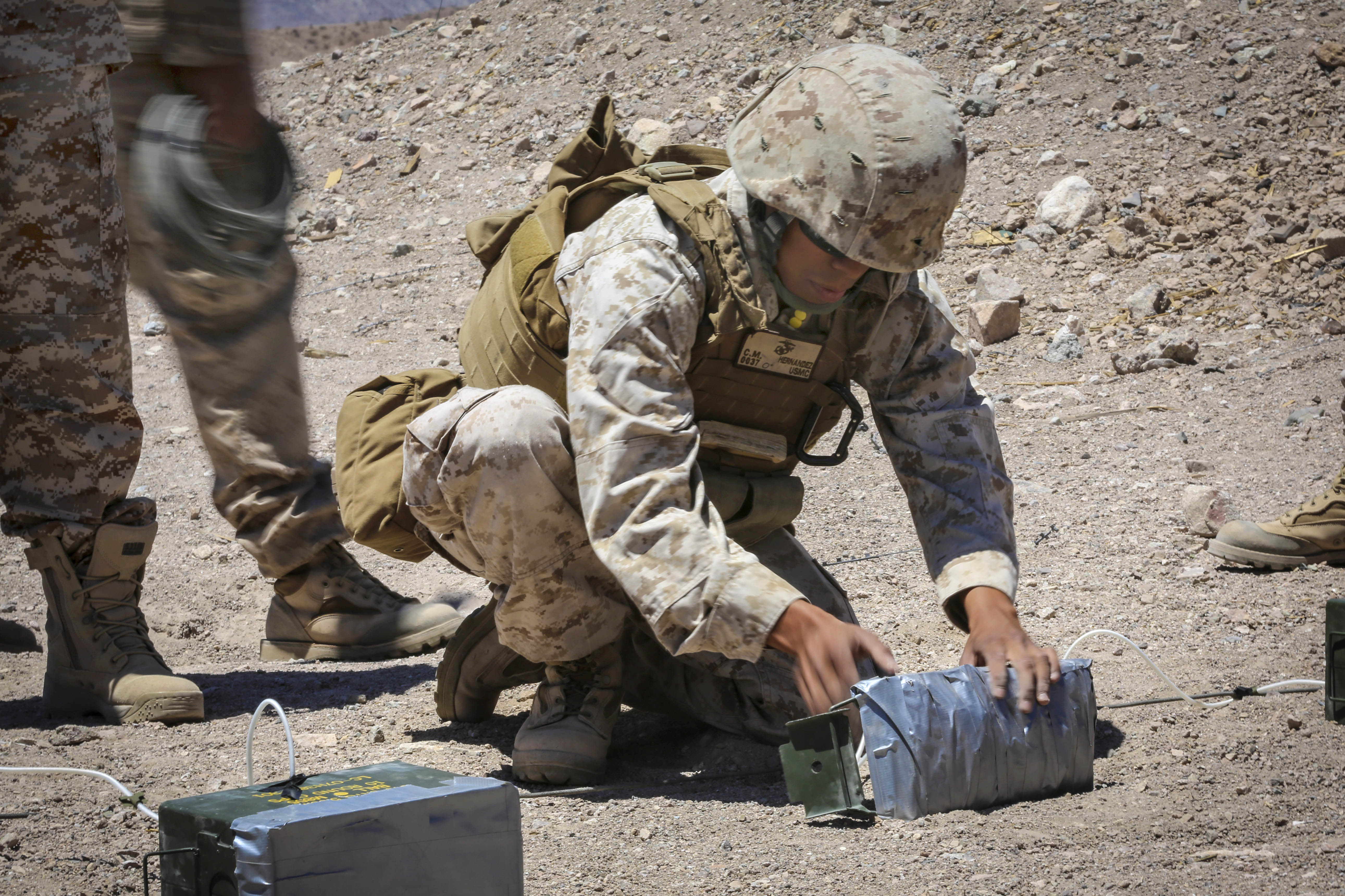 Marine Corps Lance Cpl. Carlos M. Hernandez, center, readies an ...