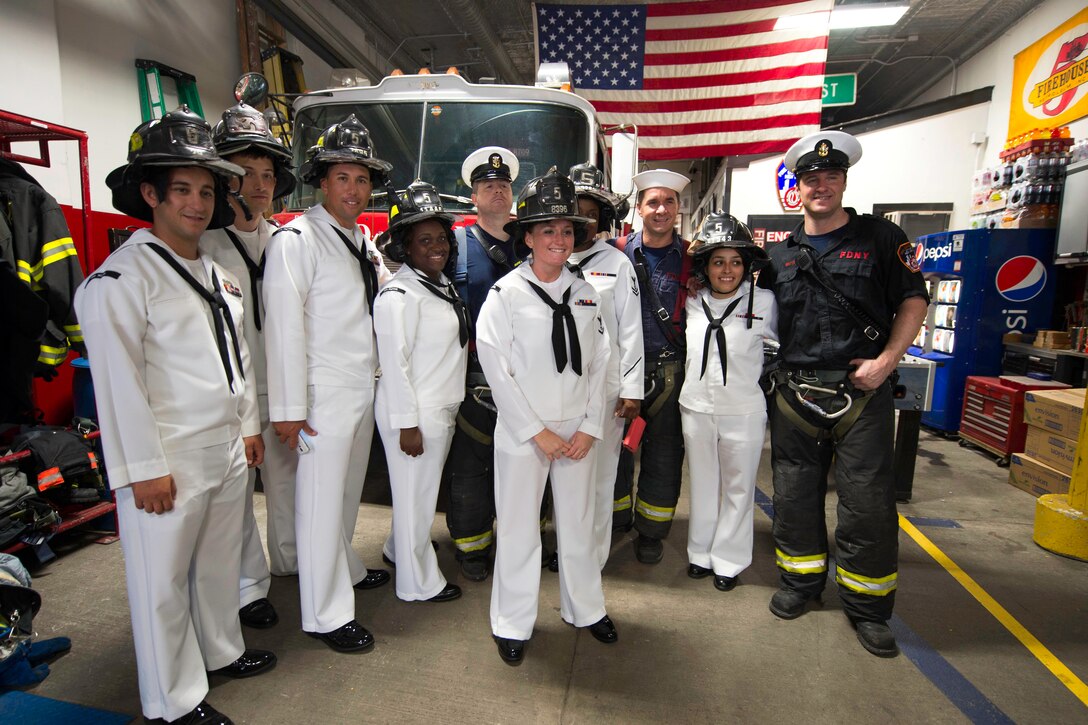 Sailors assigned to the guided missile destroyer USS McFaul pose for a ...