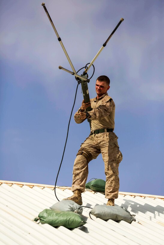 U.S. Marine Corps 1st Lt. Justin Forsberg takes down the last antenna ...
