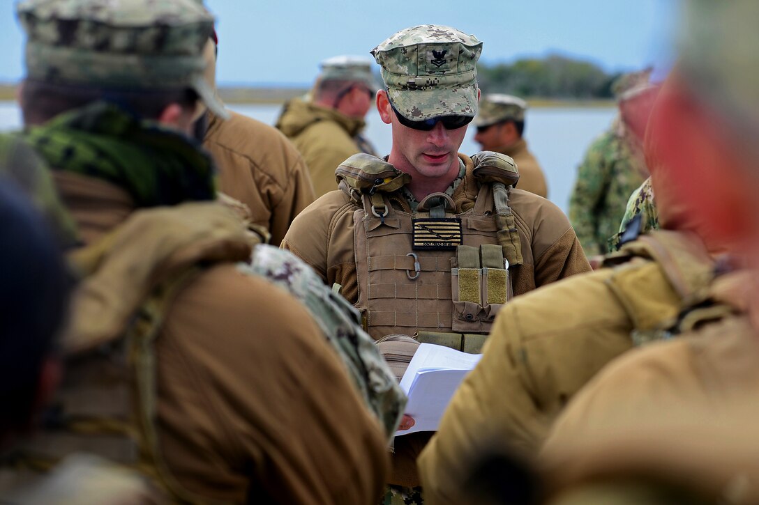 Navy Petty Officer 2nd Class Ethan Bowne briefs Marines before a ...