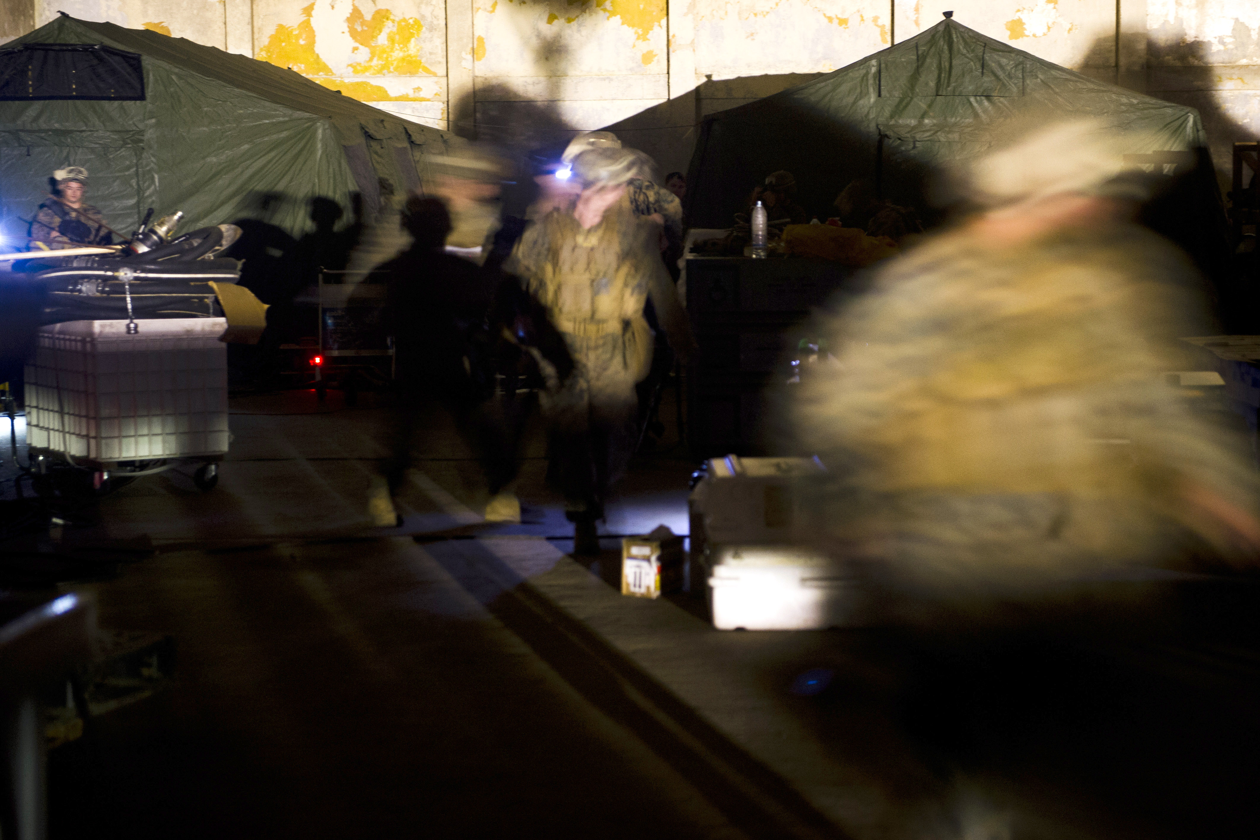 U.S. Marines gather their gear during an exercise with U.S. airmen ...