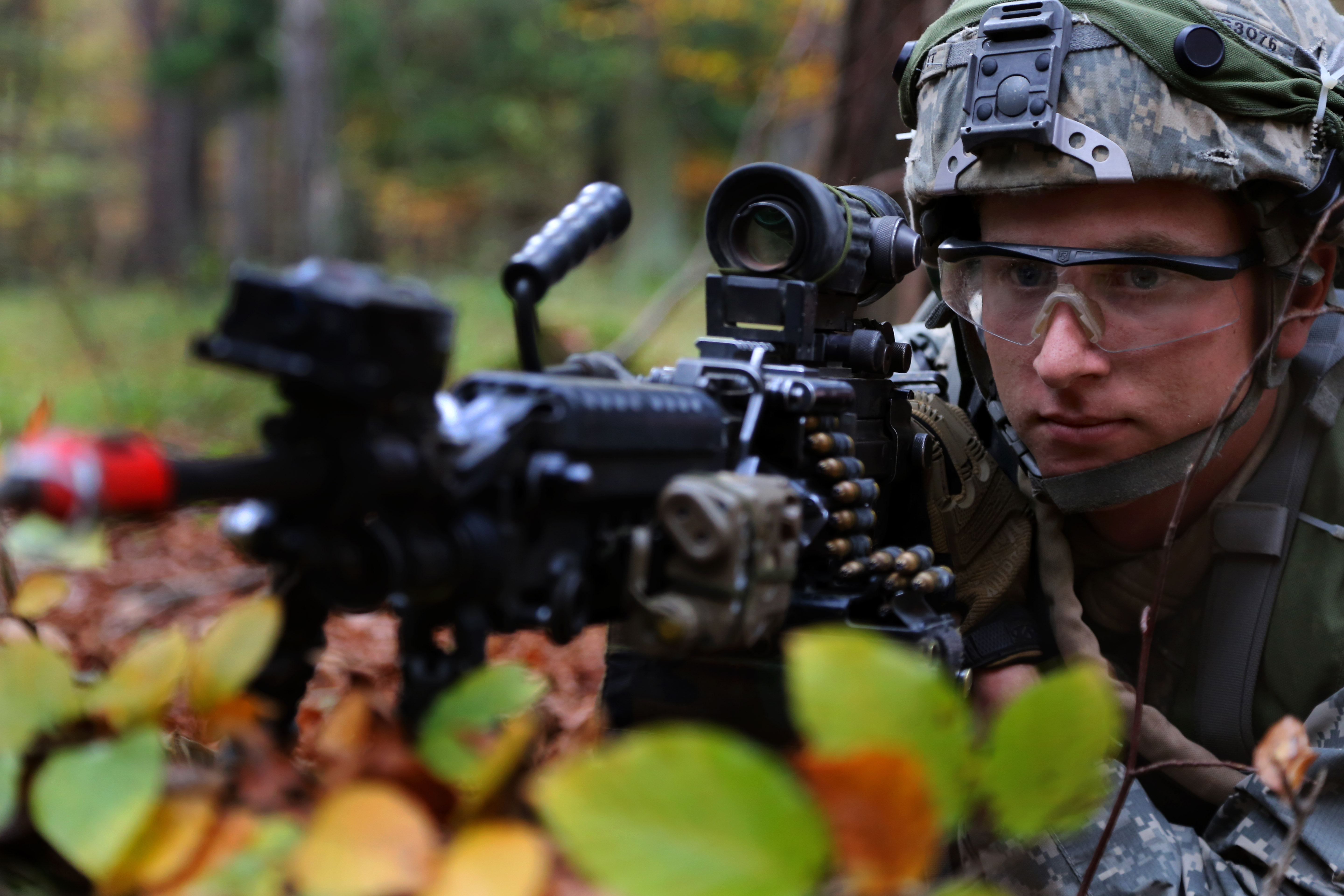 U.S. Army Pvt. Jordan Gott provides security with an M249 light machine ...