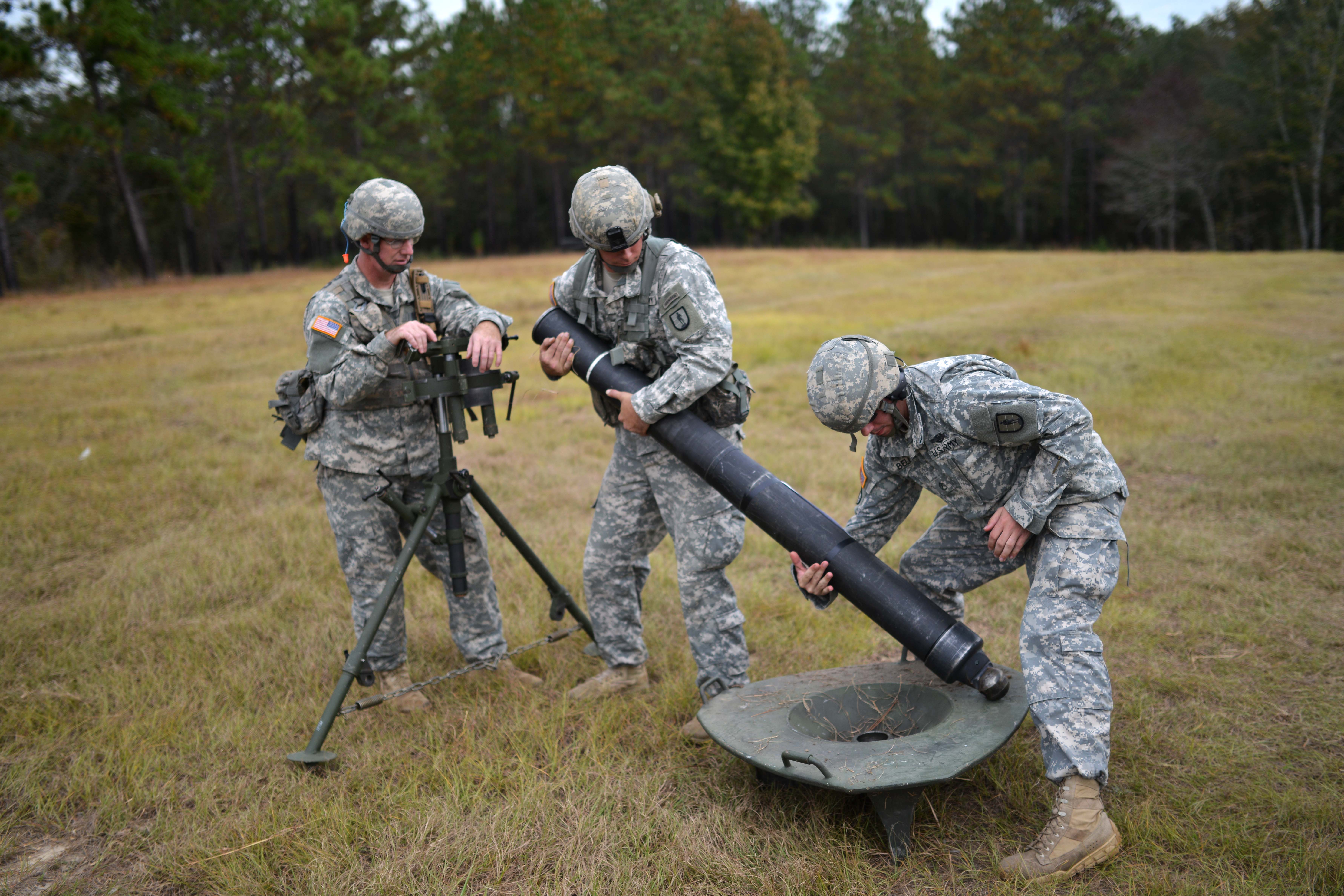 Soldiers prepare a mortar system for their team at the firing range ...