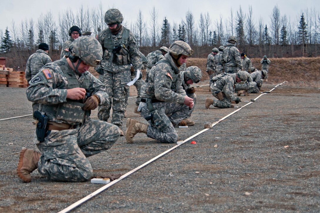 Soldiers load ammunition into their magazines during the U.S. Army ...