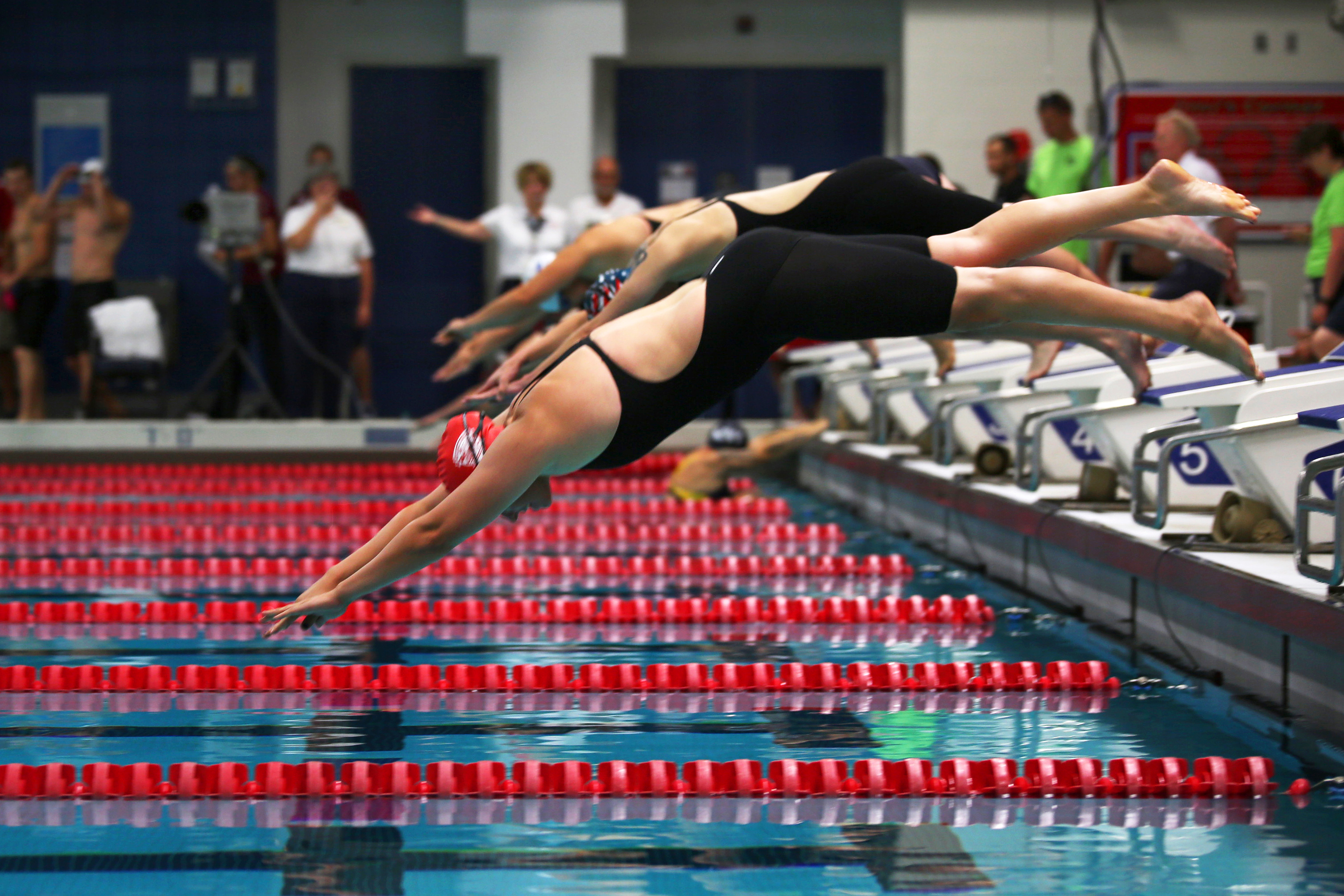 Marine Corps Staff Sgt. Maryann Miller, foreground, dives into the ...