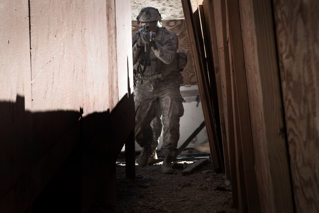 Soldiers move between buildings after breaching an enemy compound ...