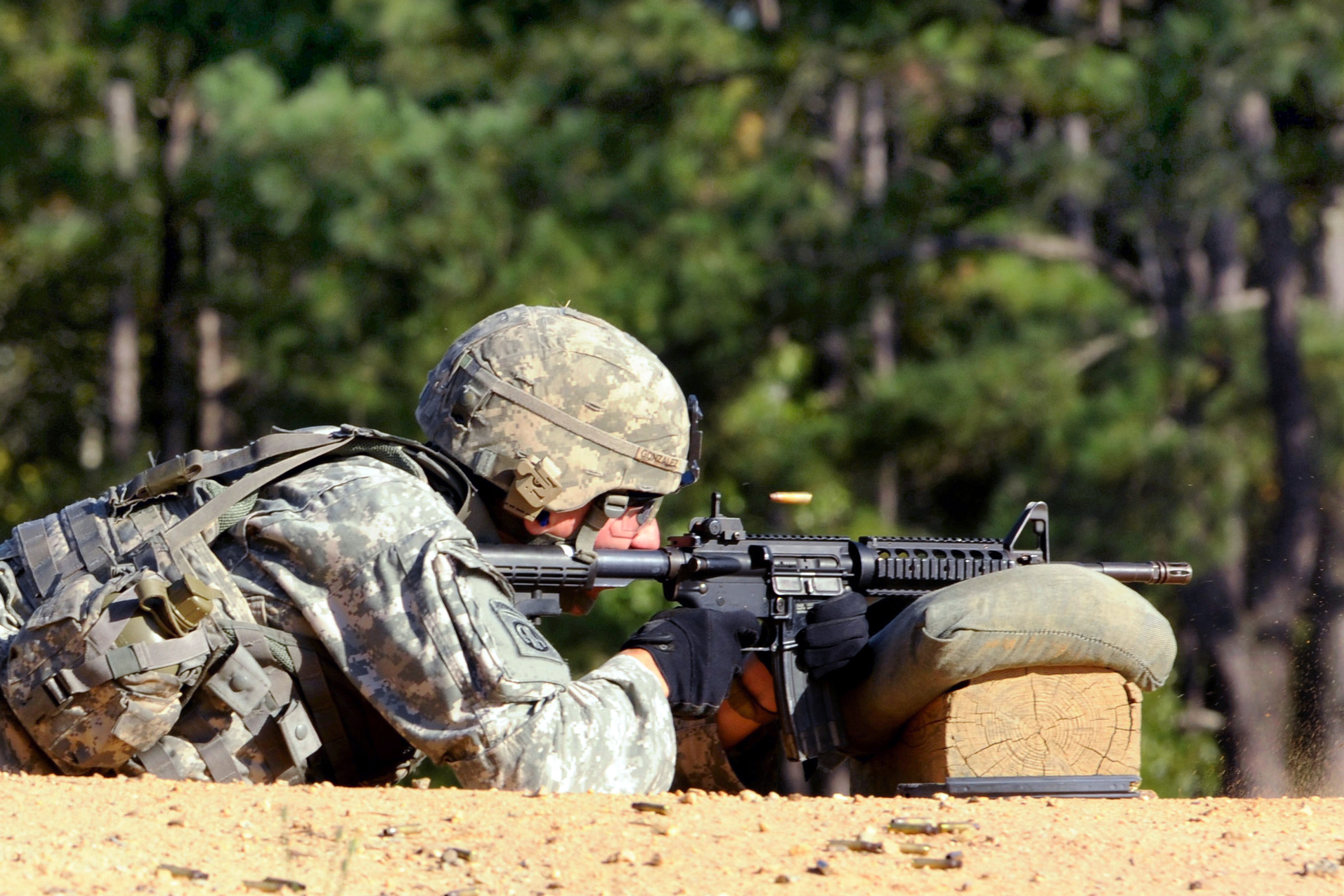 A soldier fires his M4 carbine rifle during a stress shoot range at the ...