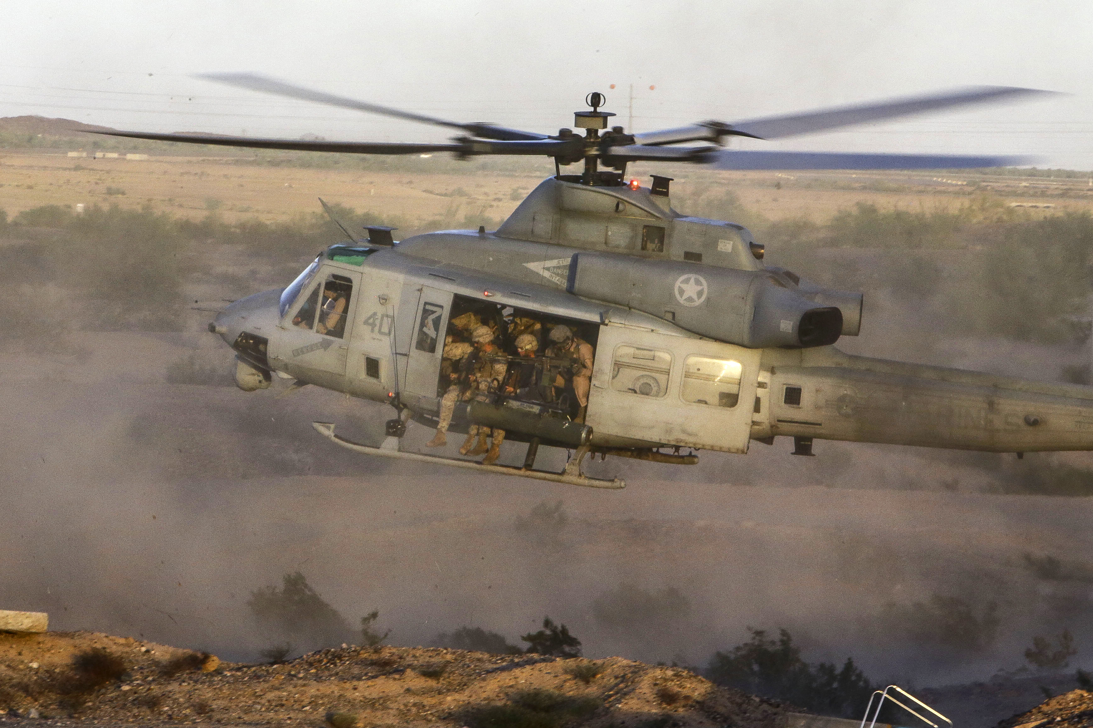 A Marine Corps UN-1Y Huey helicopter prepares to insert Marines during ...
