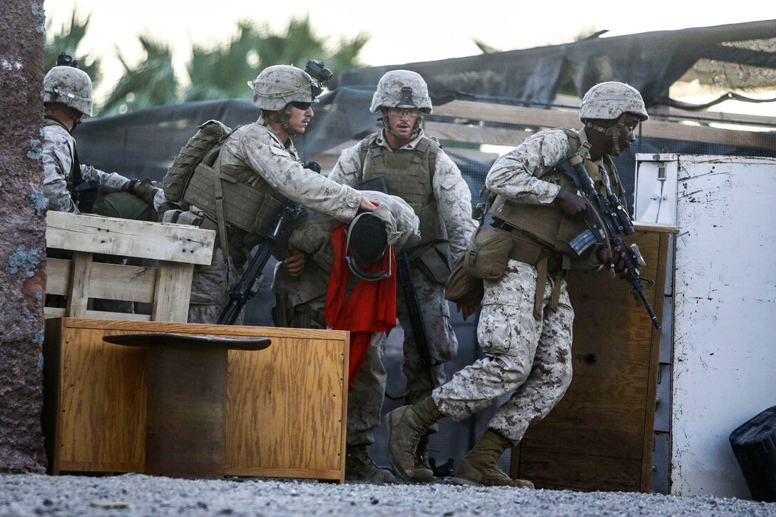 Marines detain and escort a simulated high-value target during a raid ...