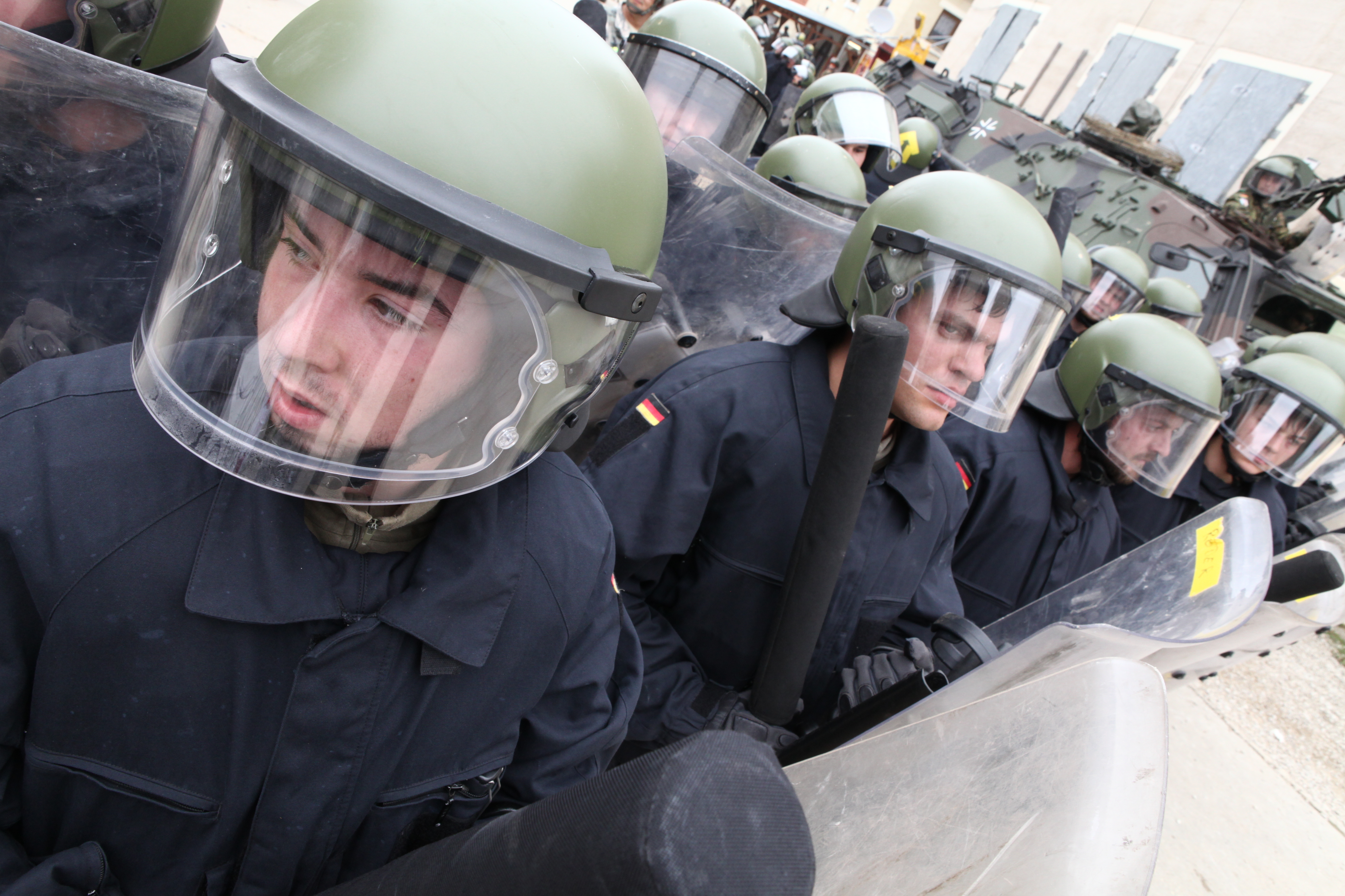 German soldiers maintain their crash line during riot control training ...