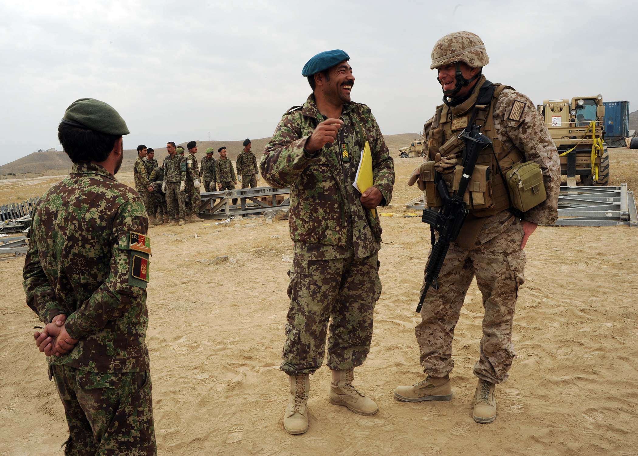 Sgt. Achmad Hussein, left, of the Afghan national engineer brigade shares a laugh with U.S. Navy ...