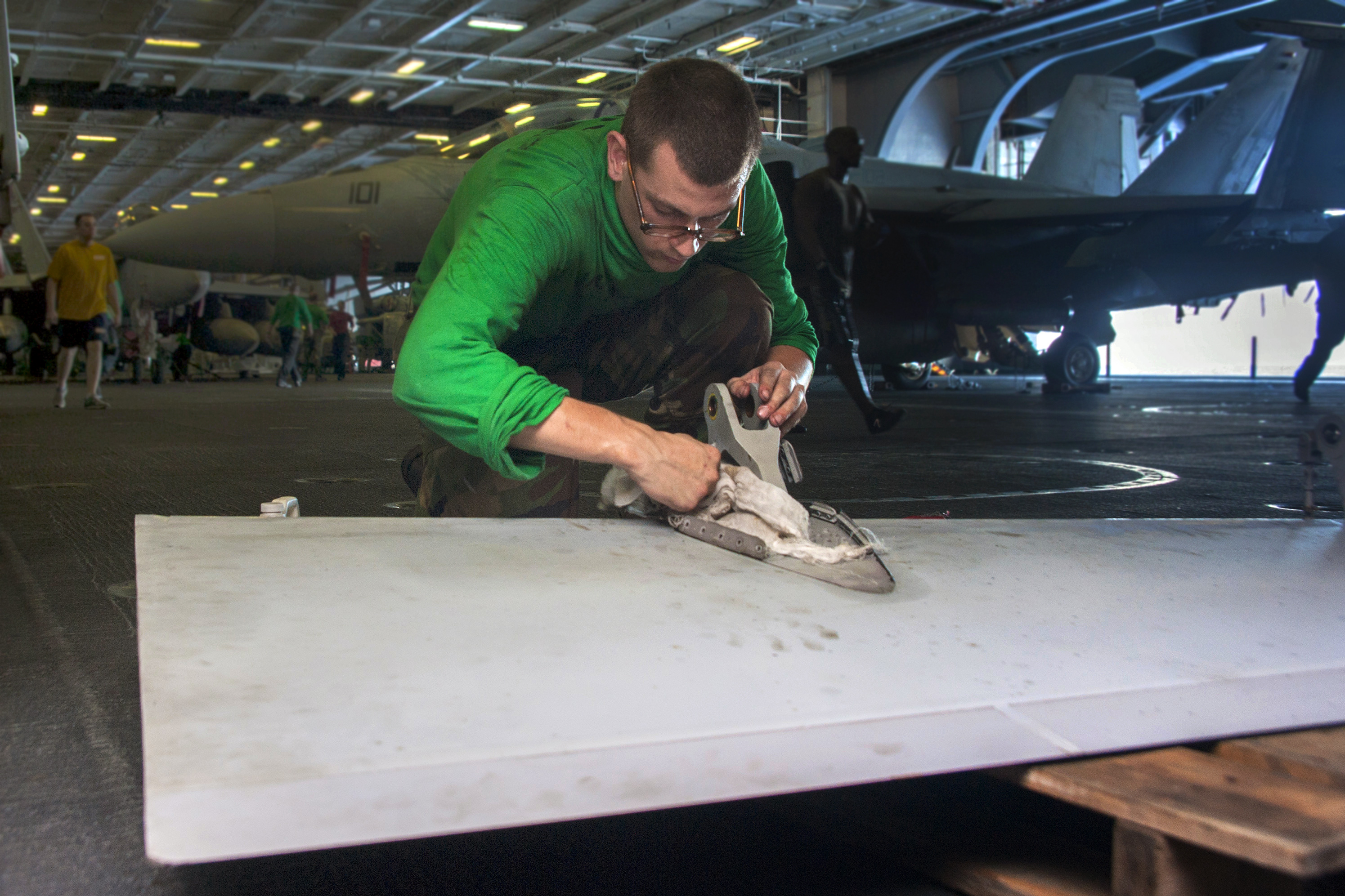 U.S. Navy Seaman Timothy O'Connor performs maintenance on aircraft ...