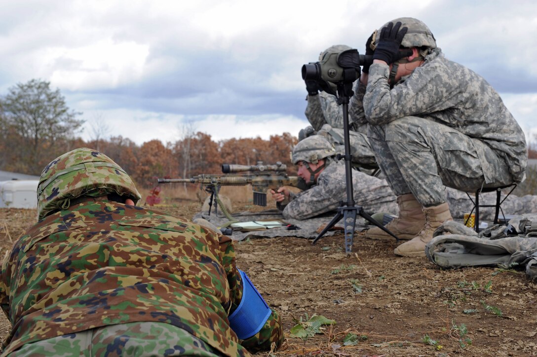 A member of the Japan ground self-defense force observes U.S. soldiers ...