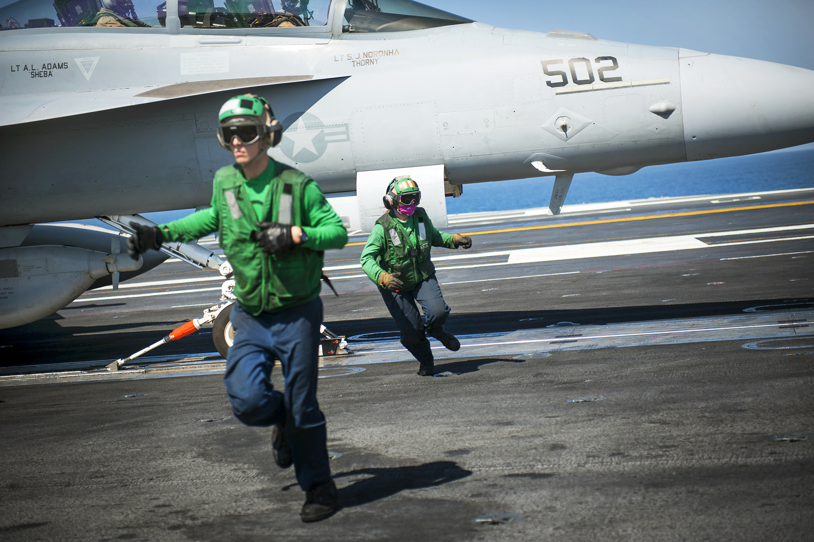 U.S. Navy Petty Officers 3rd Class Aaron Jones, left, and Raime Baker ...