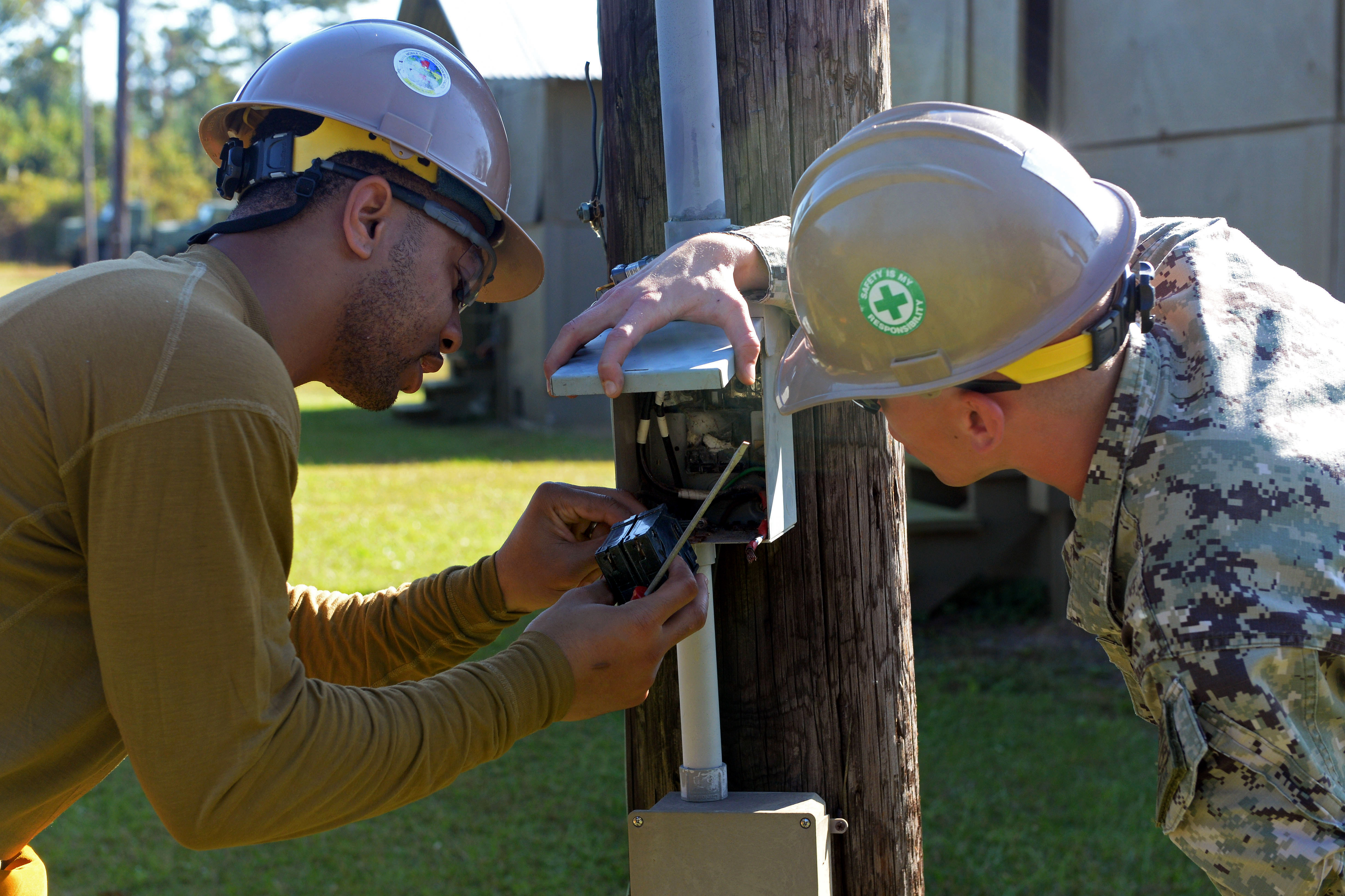 Navy Petty Officer 3rd Class Charles Johnson, left, and Navy Seaman Tim ...