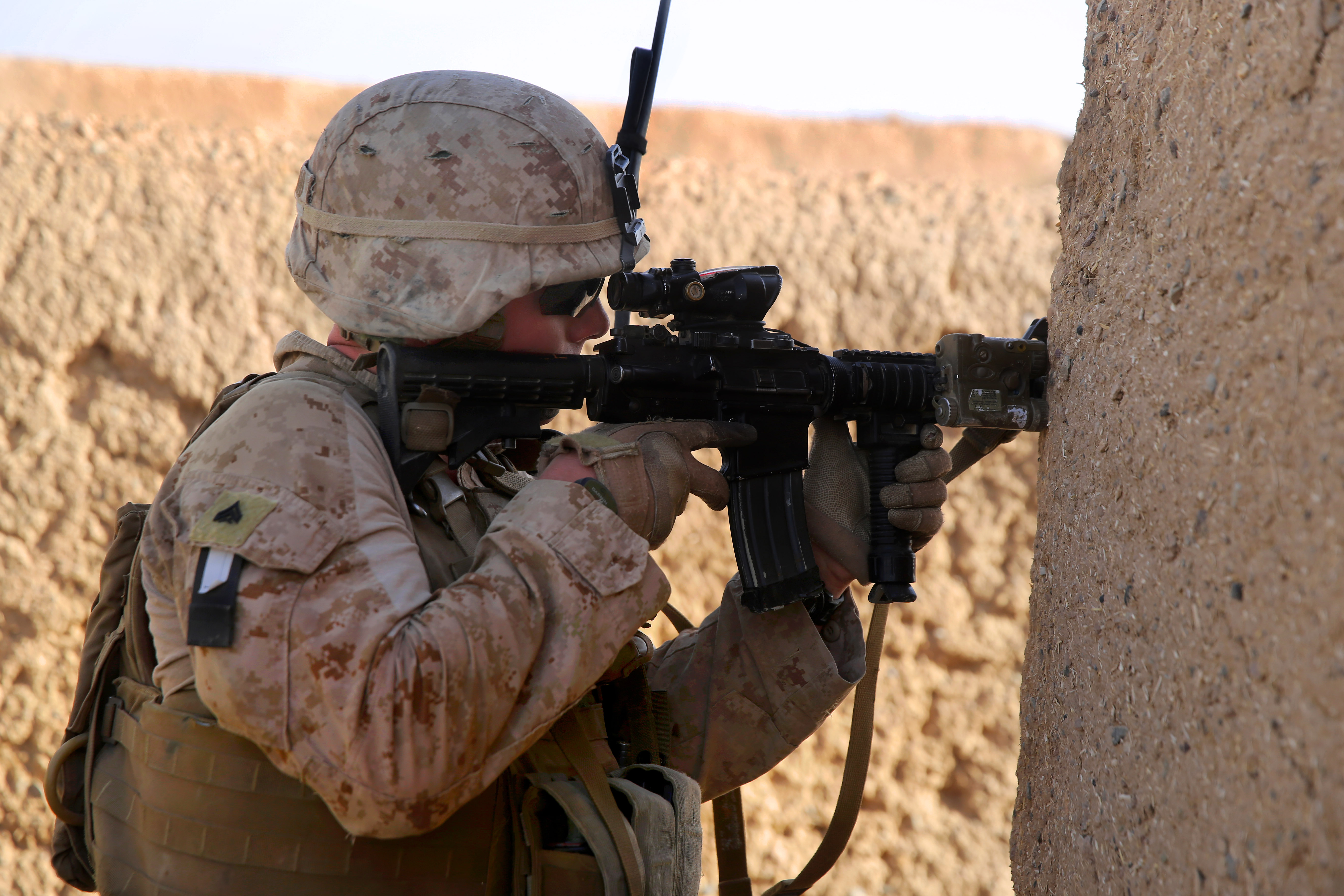 U.S. Marine Corps Cpl. Kyle Greenwood provides security from the corner ...