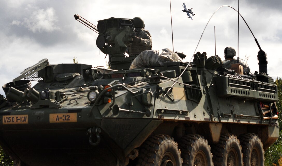 An A-10 Thunderbolt II aircraft makes a strafing run over soldiers and ...