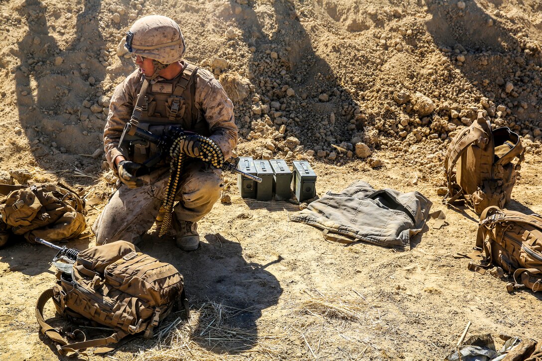 U.S. Marine Corps Lance Cpl. Travis Soares picks up rounds to resupply ...
