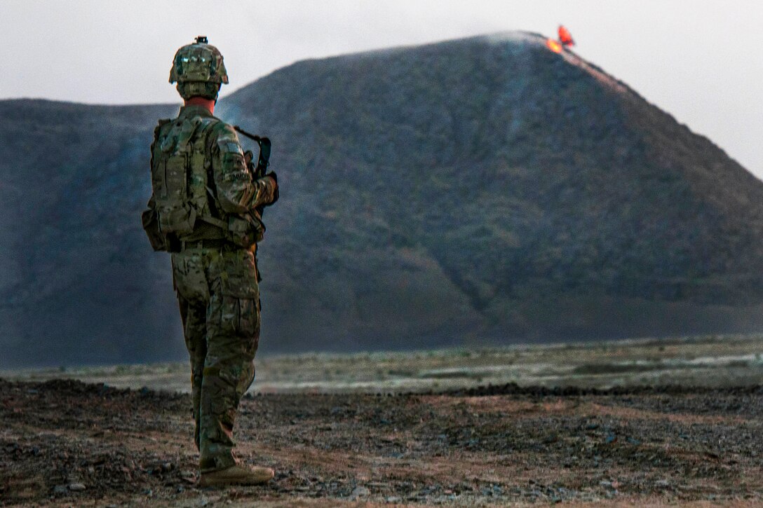 U.S. Army Staff Sgt. Dustin Simmons watches as an artillery round ...