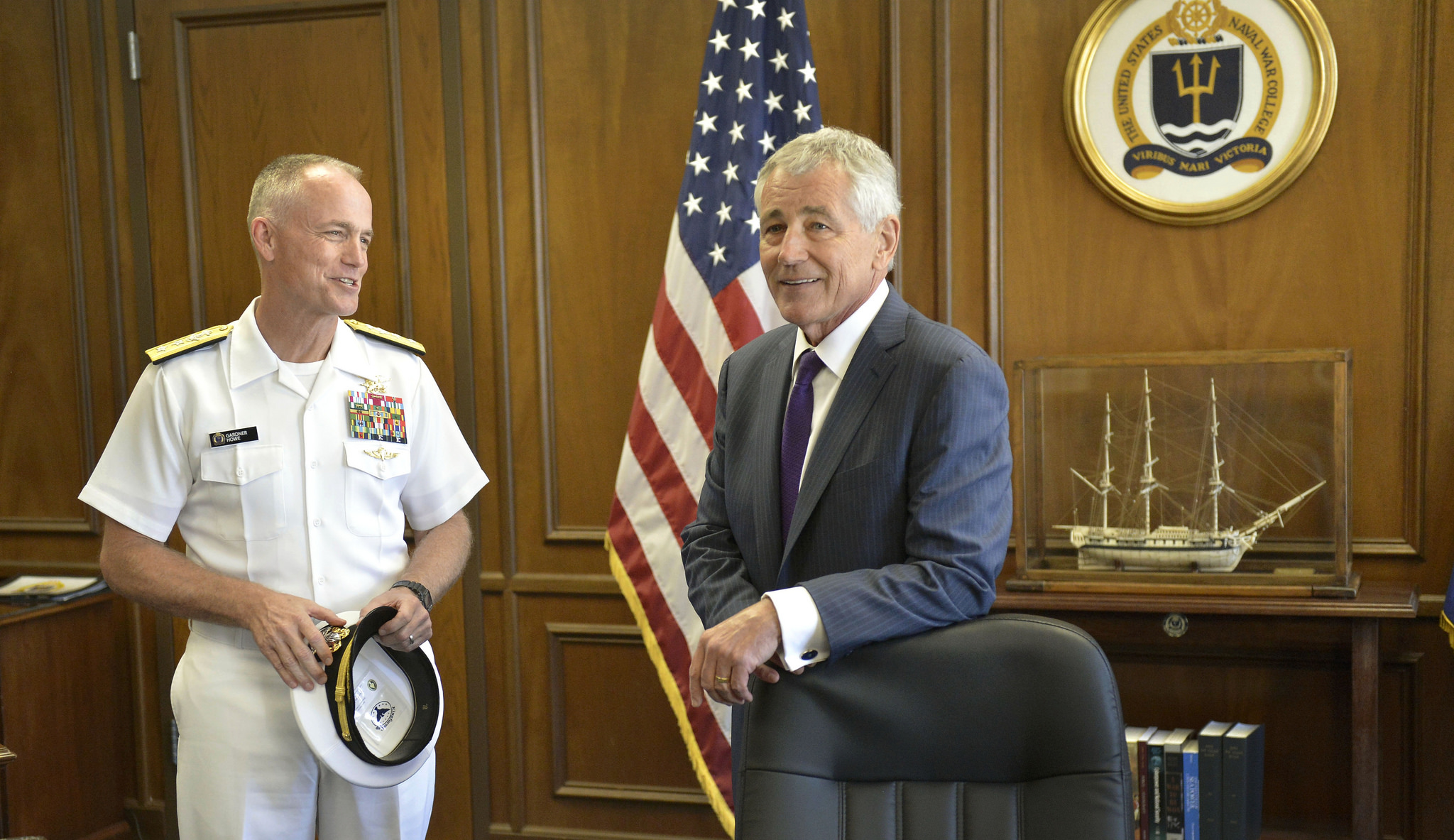 Defense Secretary Chuck Hagel, right, visits with Navy Rear Adm. P ...