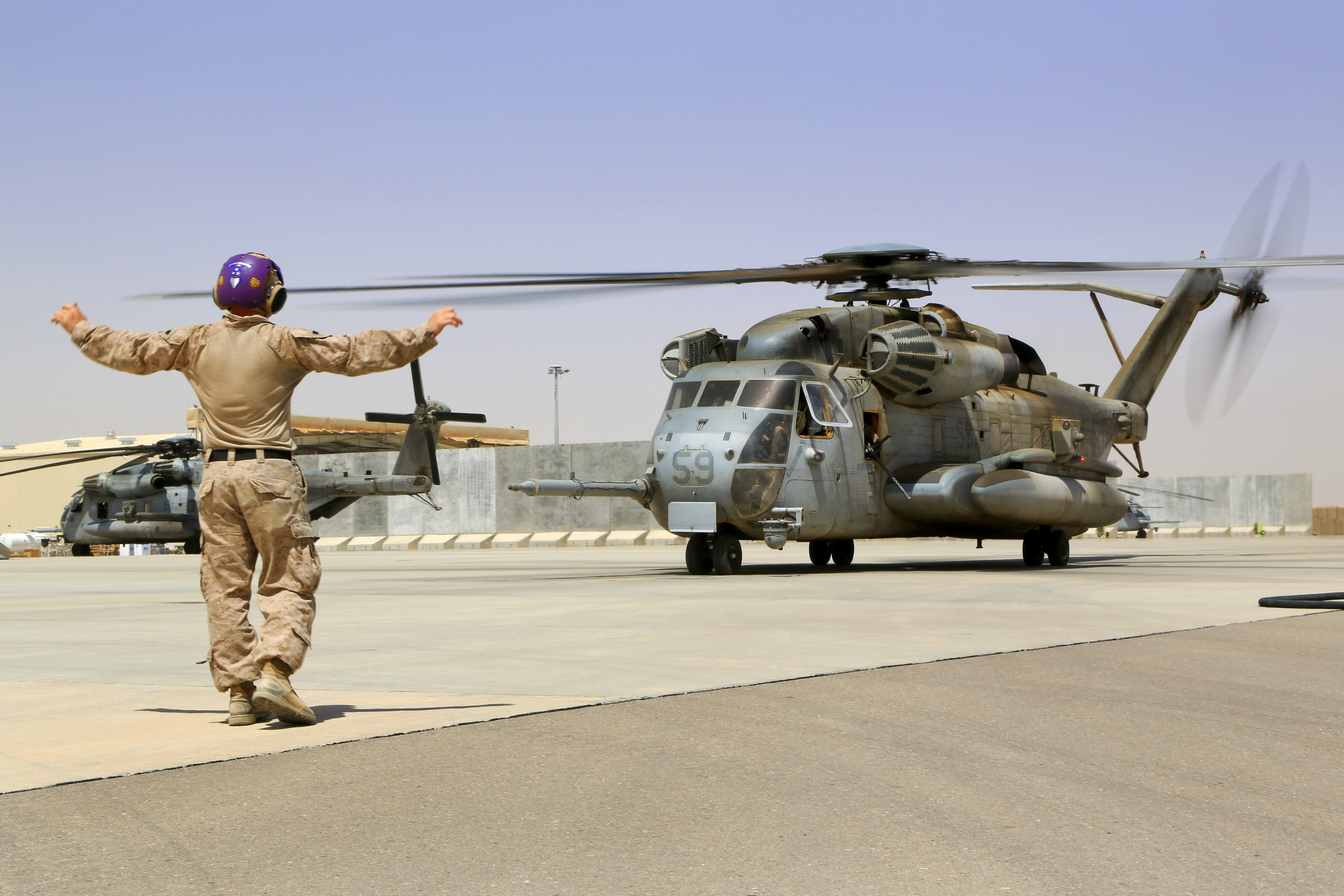 U.S. Marine Sgt. Joshua Morrison gives pilots the all clear after ...