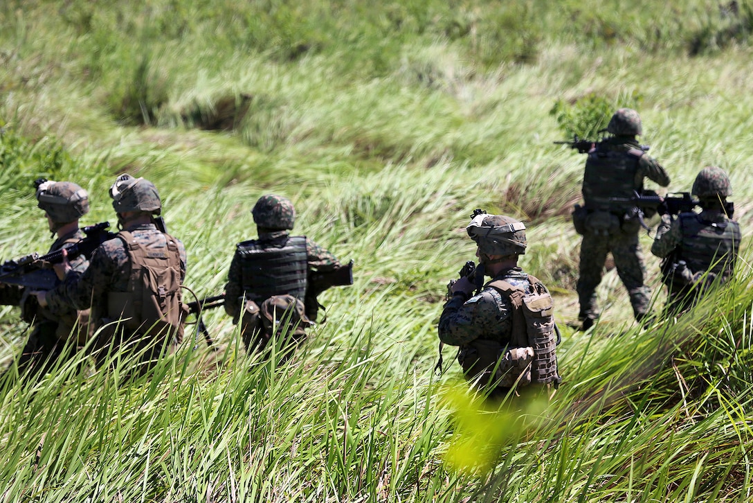 U.S. Marines and Malaysian soldiers respond to a simulated ambush ...